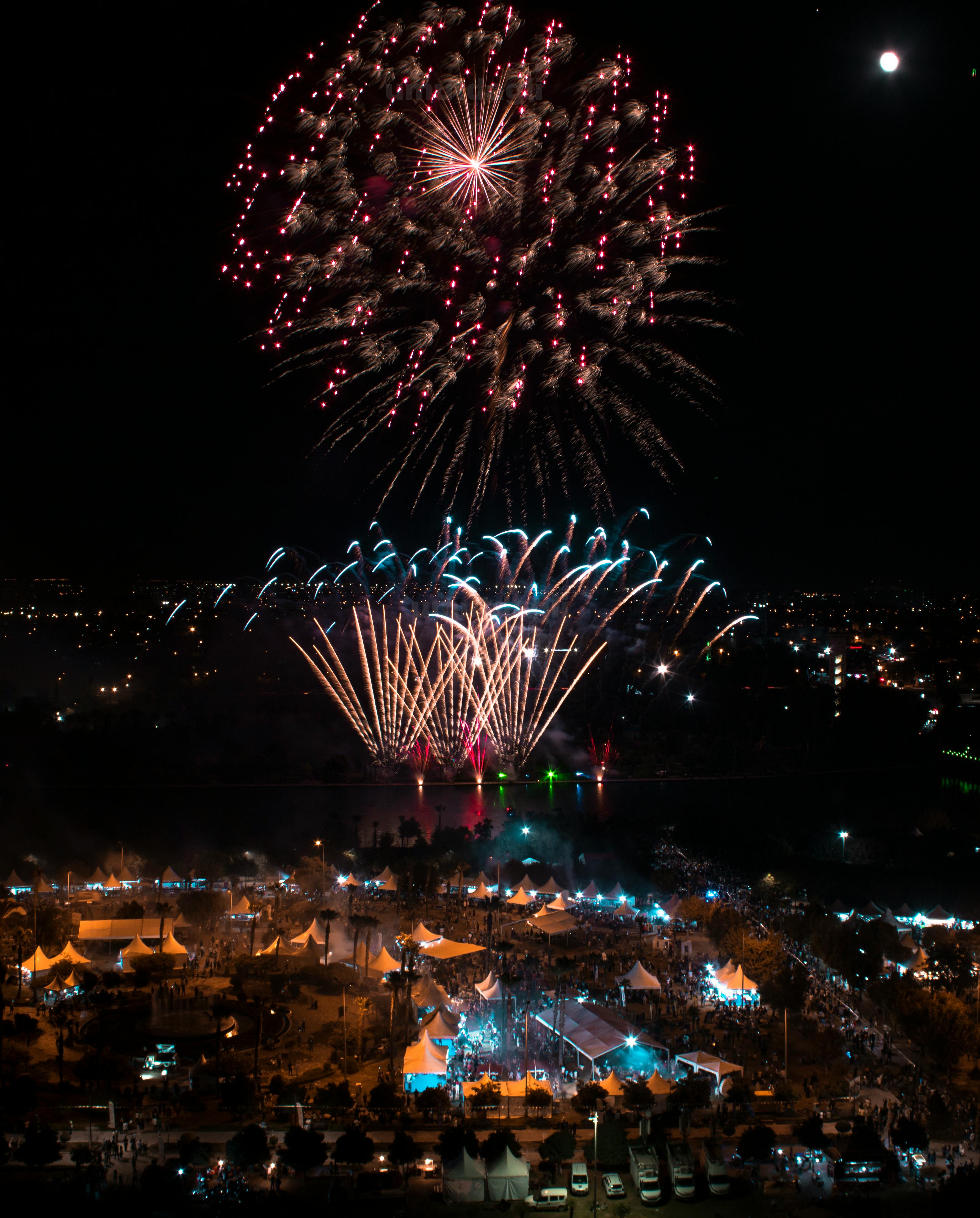 Fire Works Display Over the Sea Near City Buildings · Free Stock Photo