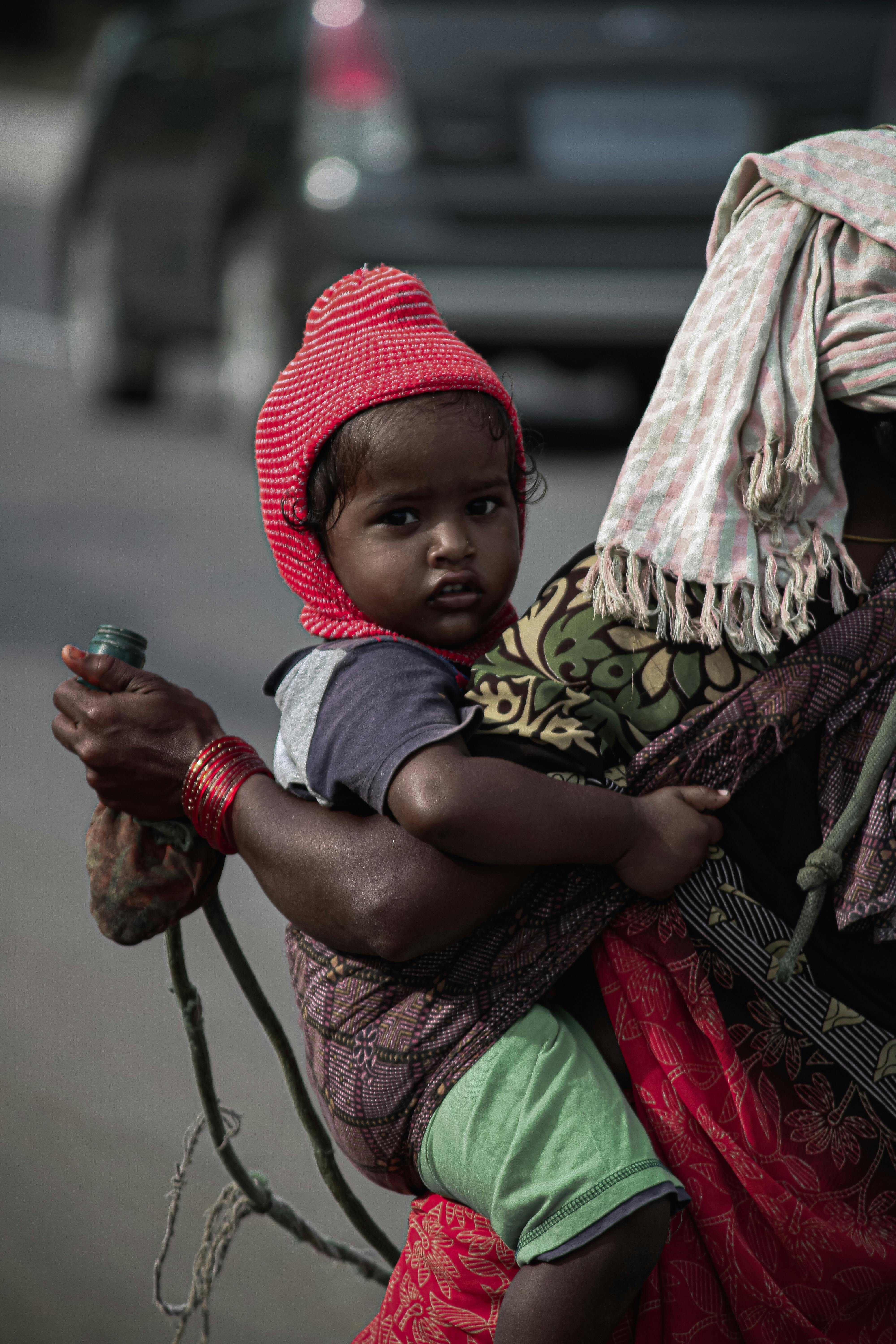 A Person Carrying a Baby while Walking · Free Stock Photo