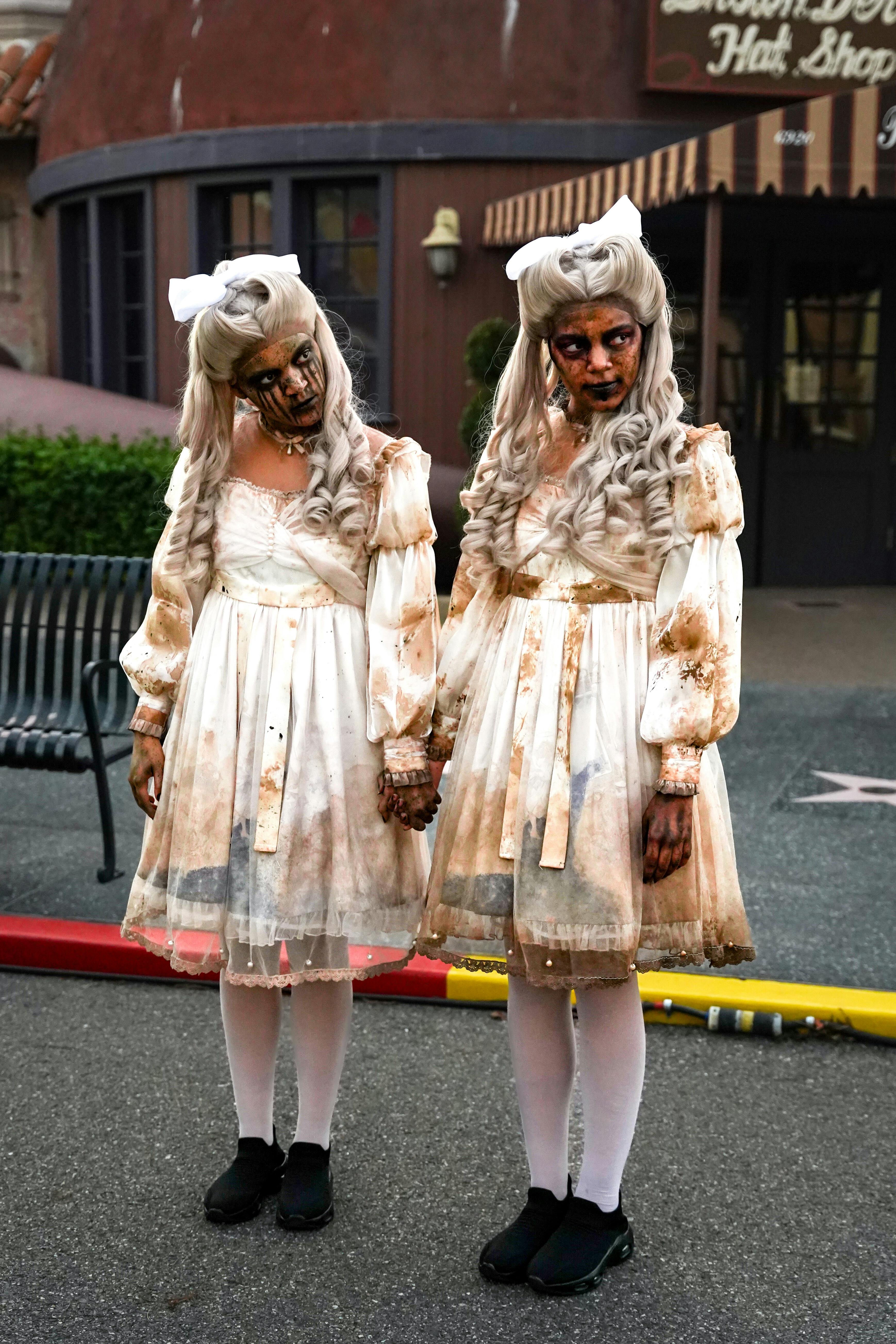 Women Dressed as Horror Twins in Cute Dresses · Free Stock Photo