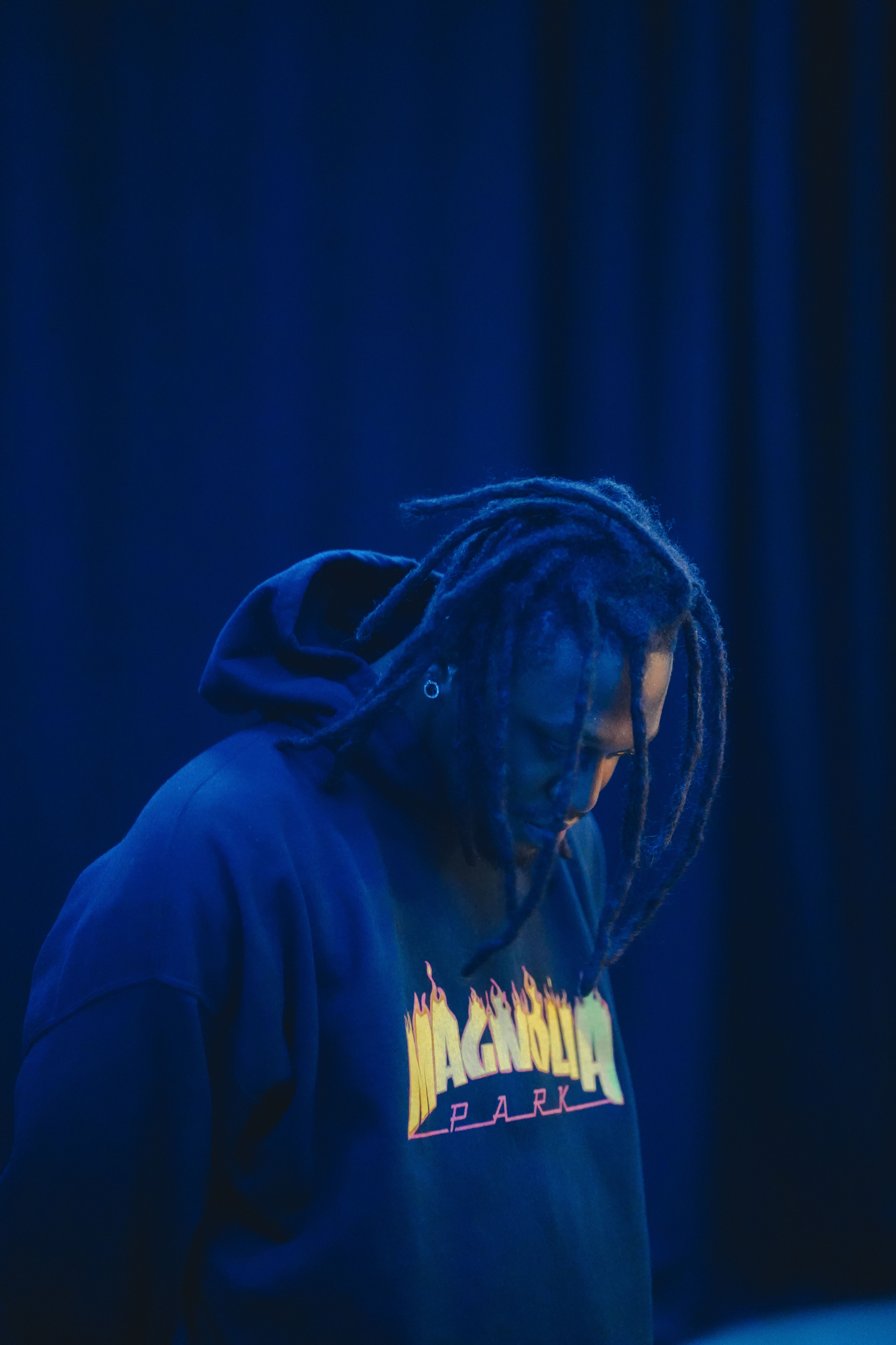 A Man with Dreadlocks Wearing Black Hoodie while Looking Down · Free ...
