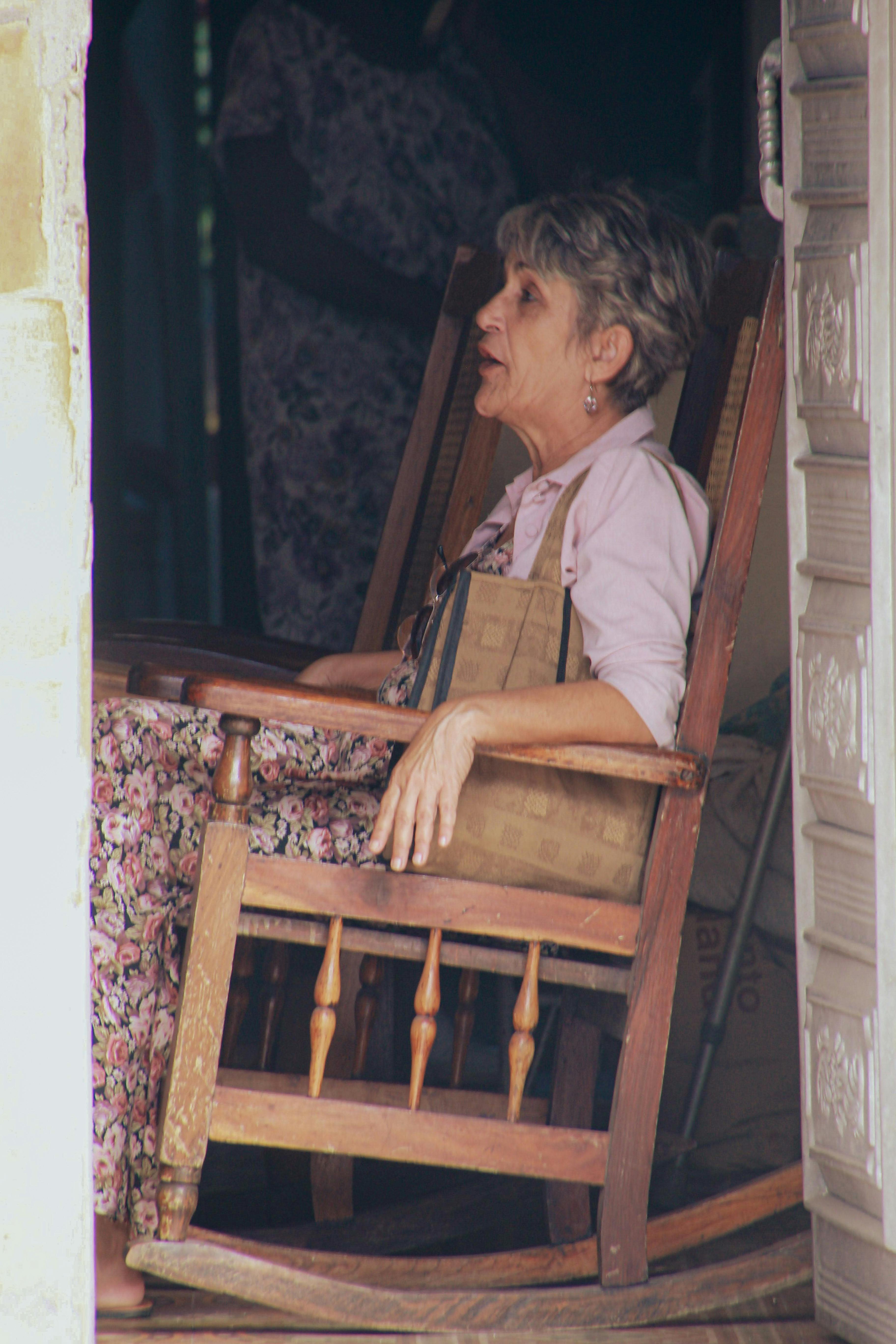 Side View of an Elderly Woman Sitting in a Rocking Chair · Free Stock Photo