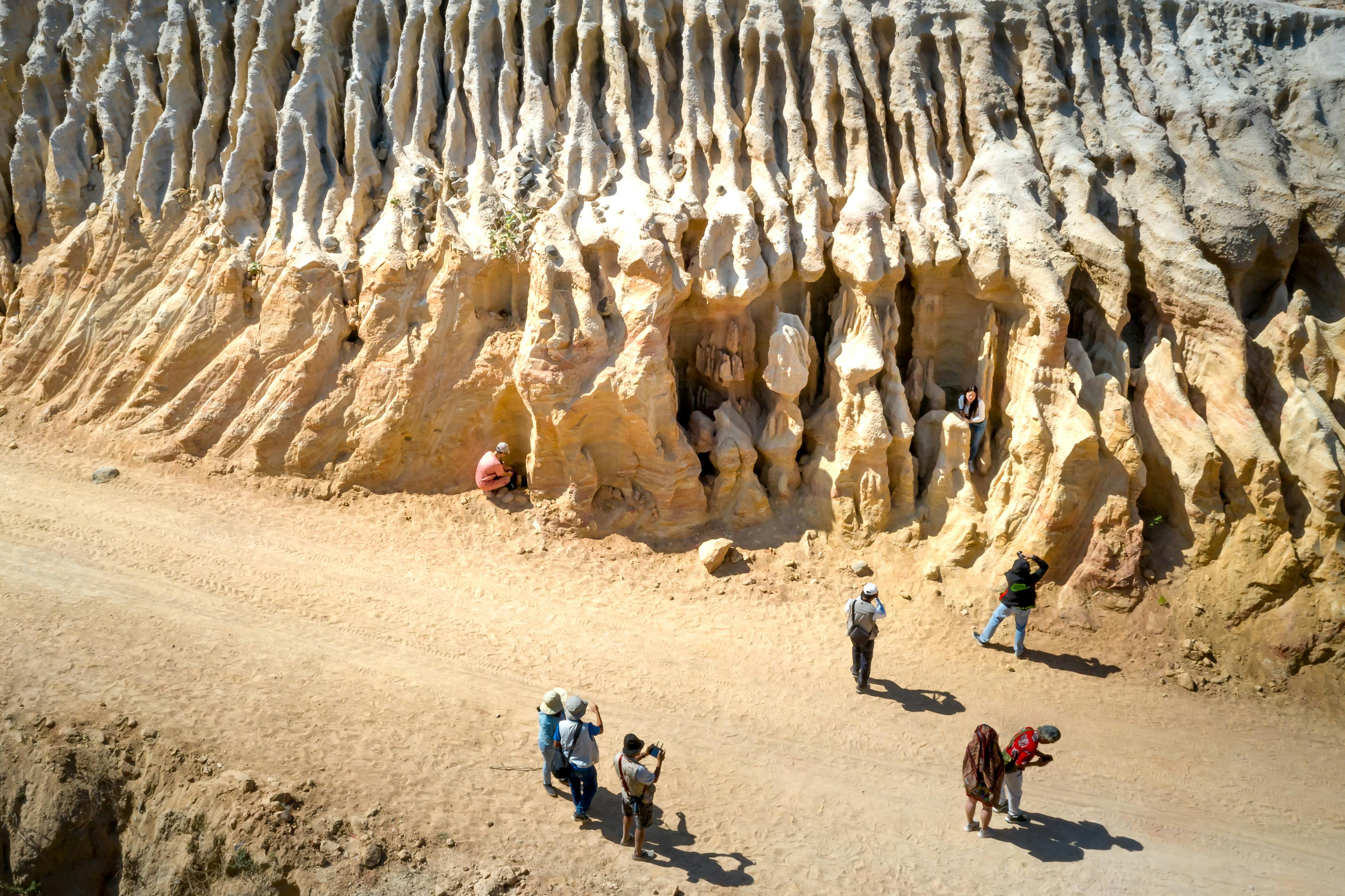 Tourists Taking Photos of Dry Rocks on Desert · Free Stock Photo