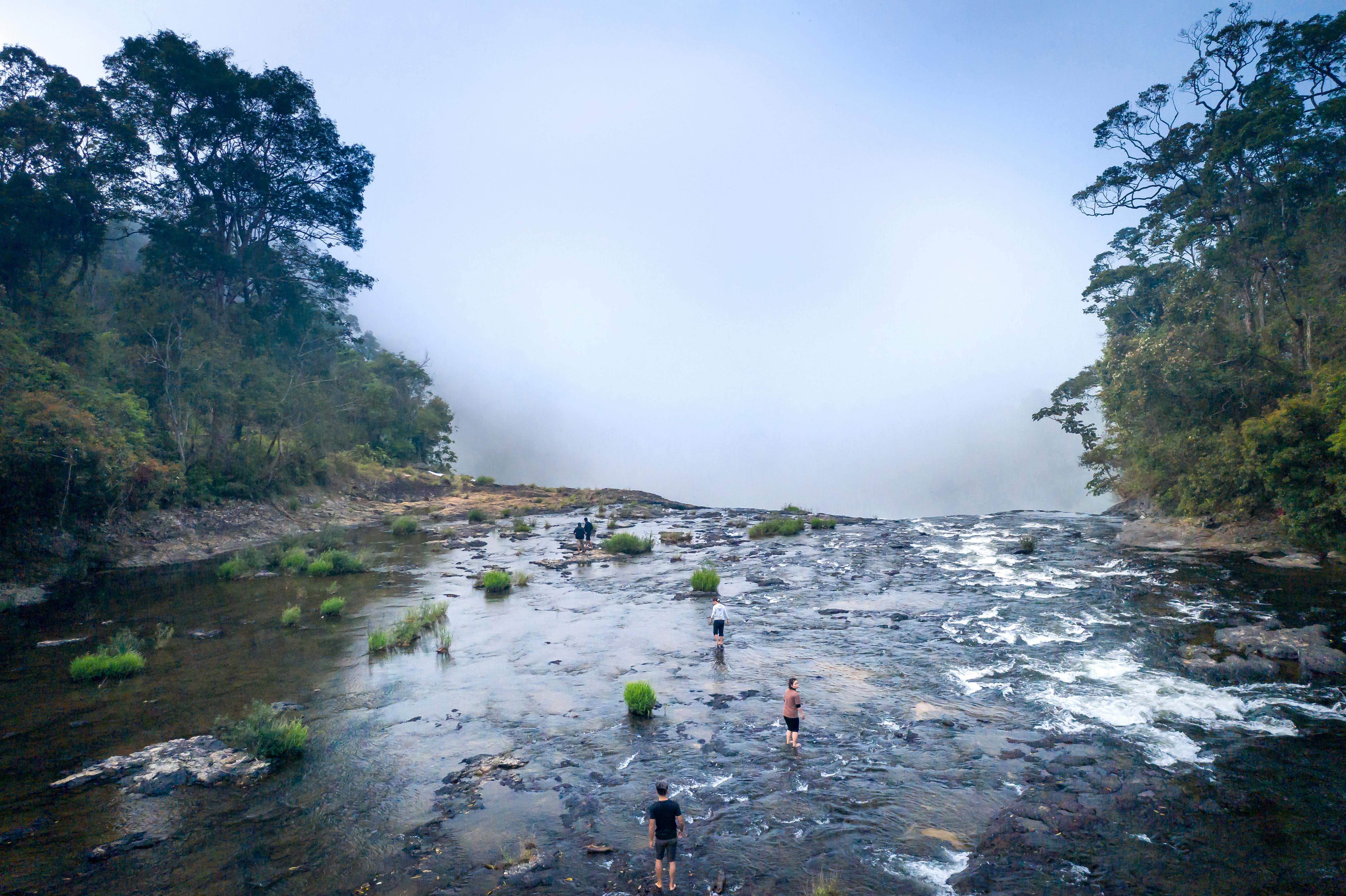 People Standing on Shallow River · Free Stock Photo