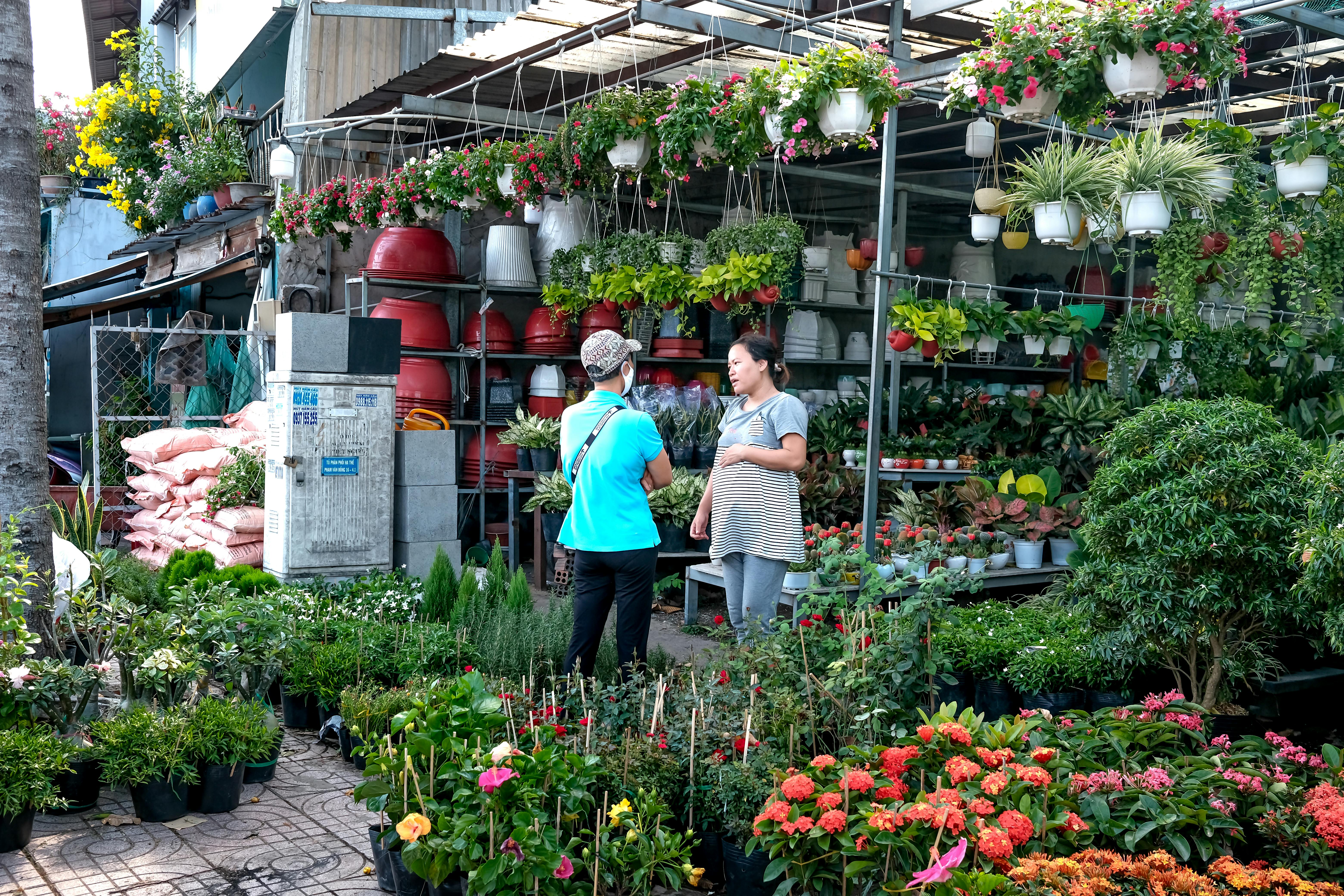 People Talking Outside of a Flower Shop · Free Stock Photo