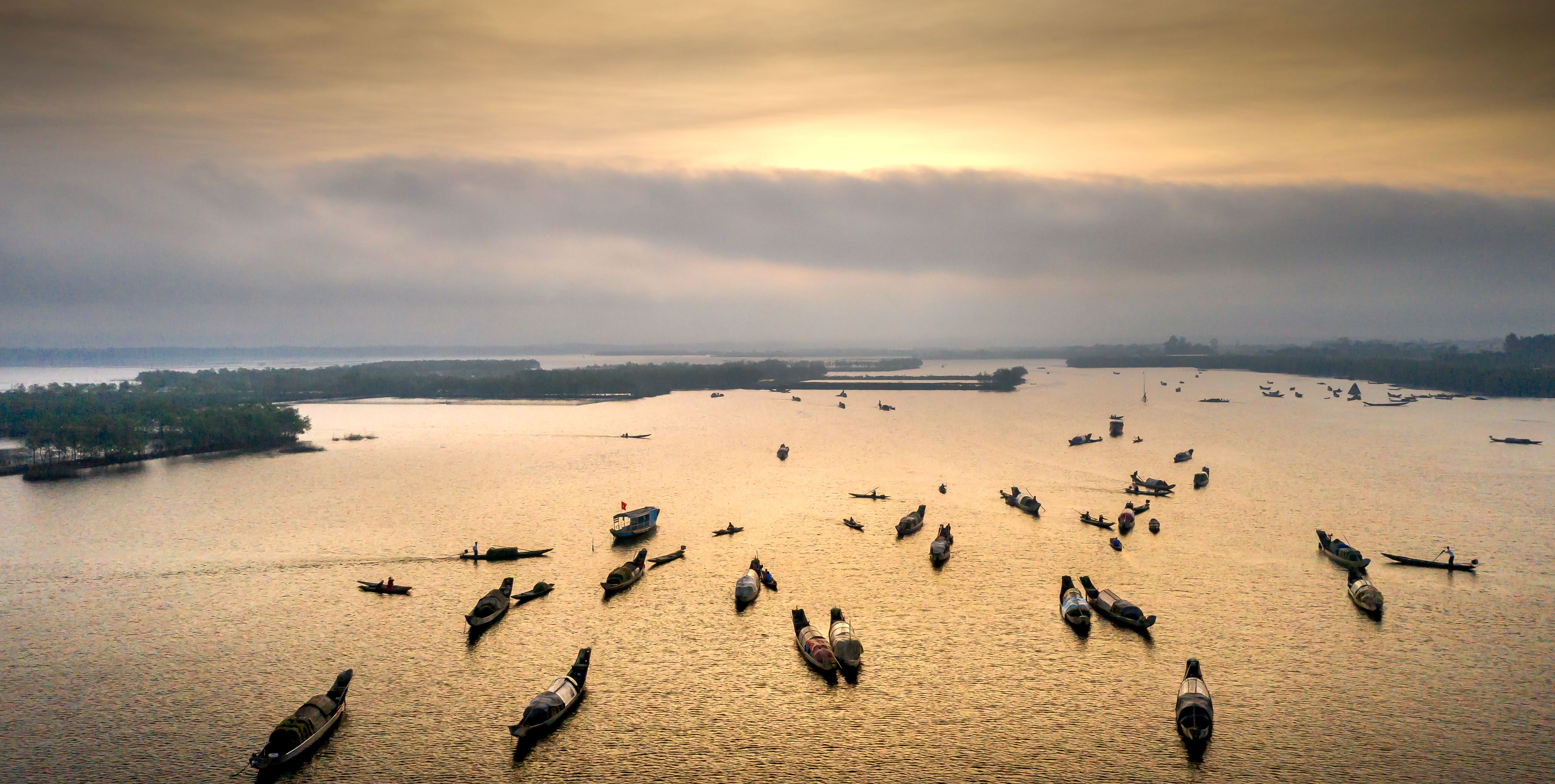 Aerial Photography of Wooden Boats Sailing on the Sea Under Evening Sky ...