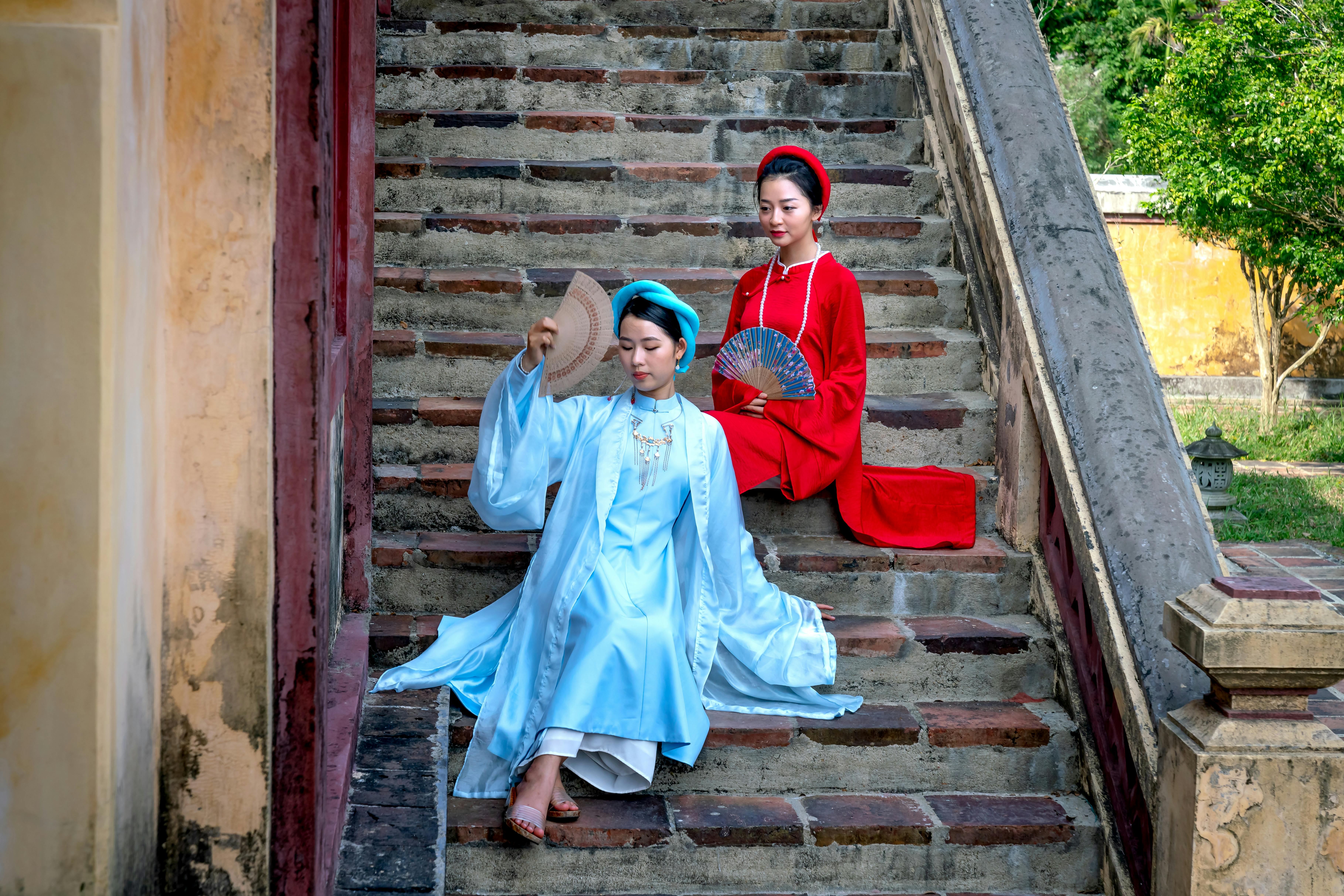 Photo of Women with Hand Fans Posing on the Stairs · Free Stock Photo