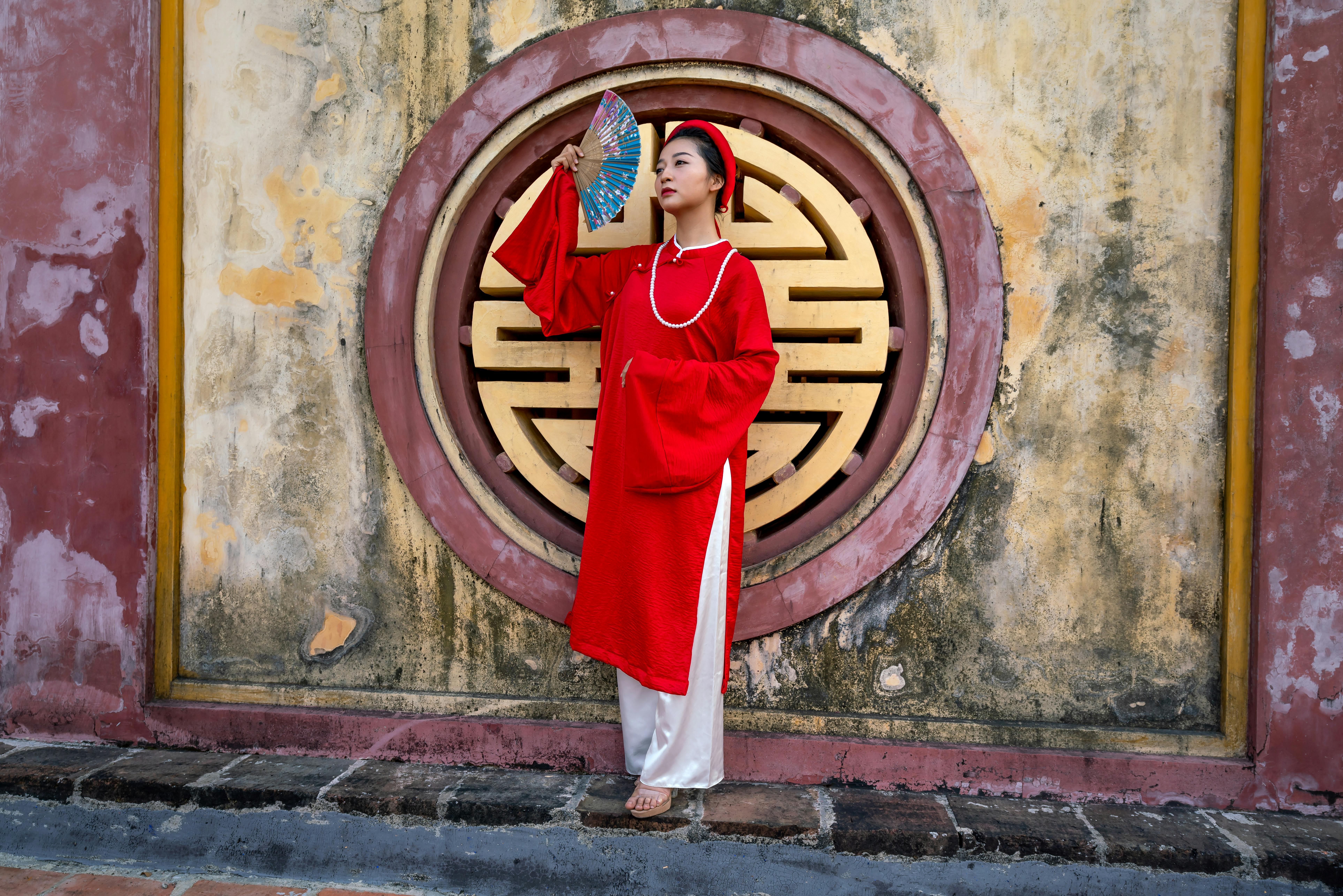 Woman Posing while Holding a Hand Fan · Free Stock Photo