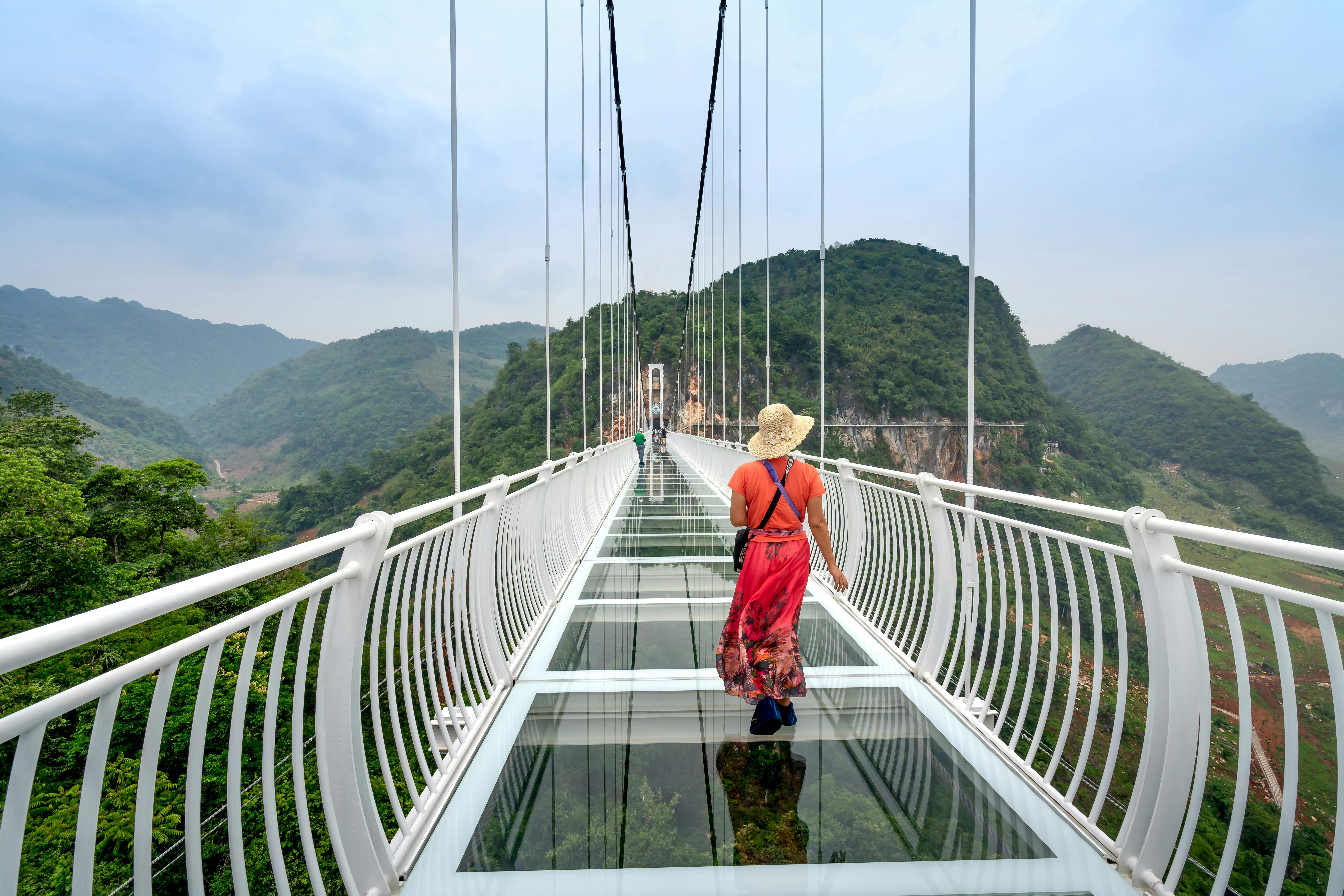 Woman Walking on a Glass Bridge · Free Stock Photo