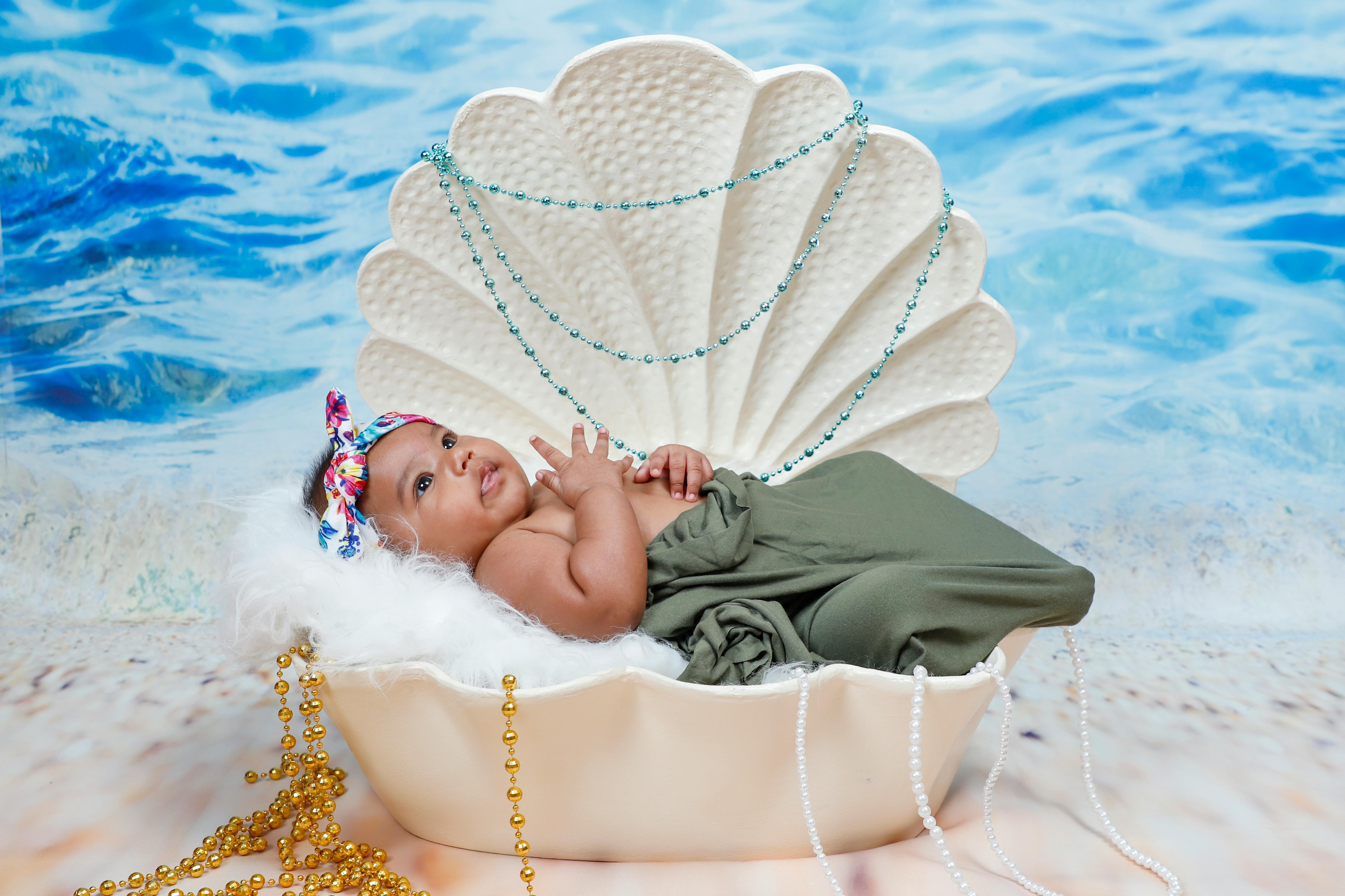 Baby Lying on White Shell · Free Stock Photo