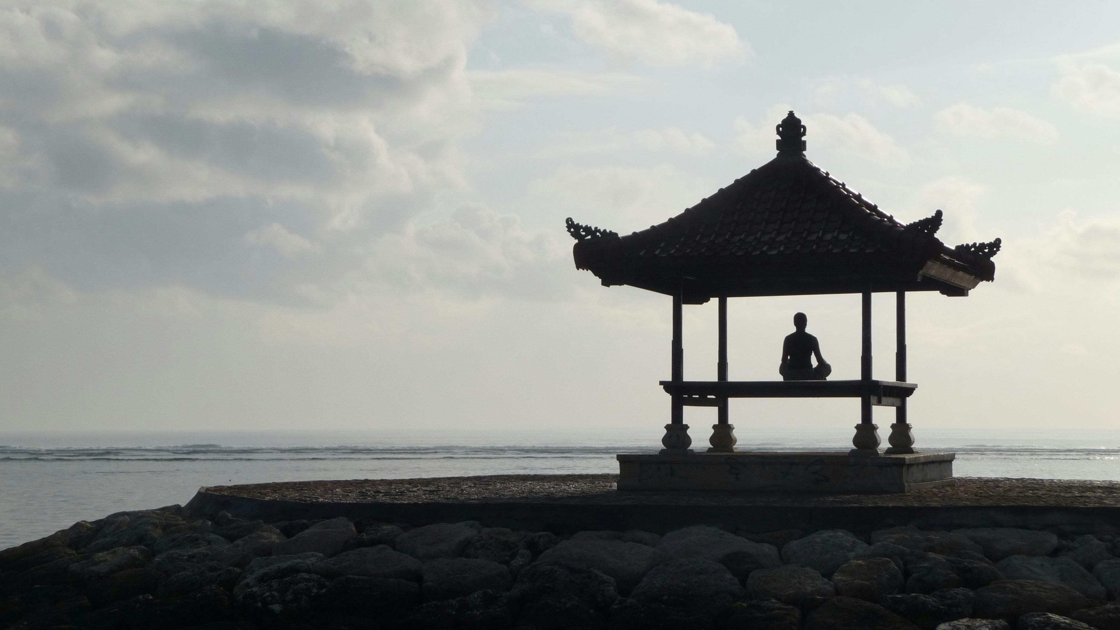 Person during Meditation in Seaside Gazebo · Free Stock Photo