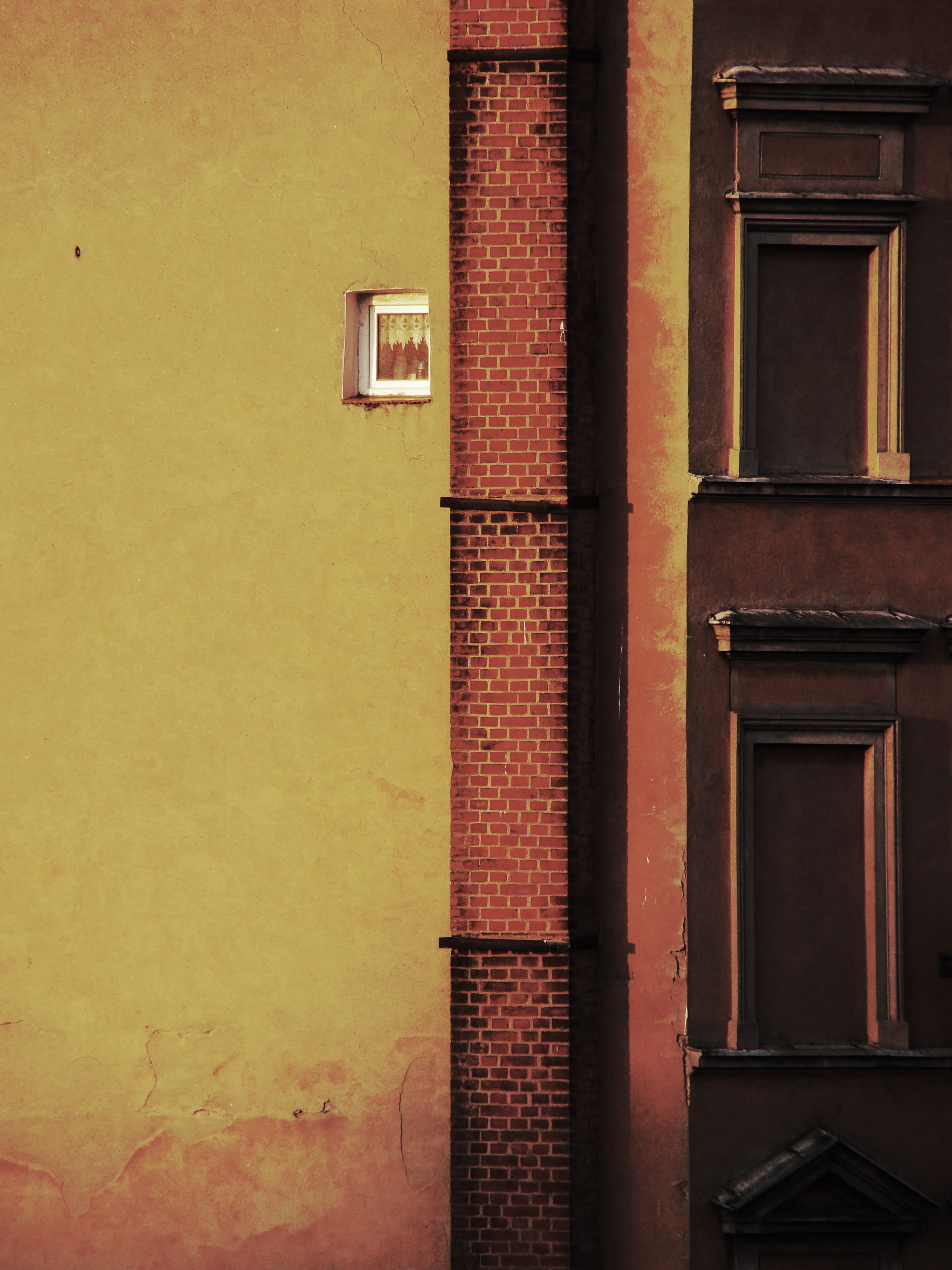 Brick Wall Between Beige and Brown Concrete Wall · Free Stock Photo