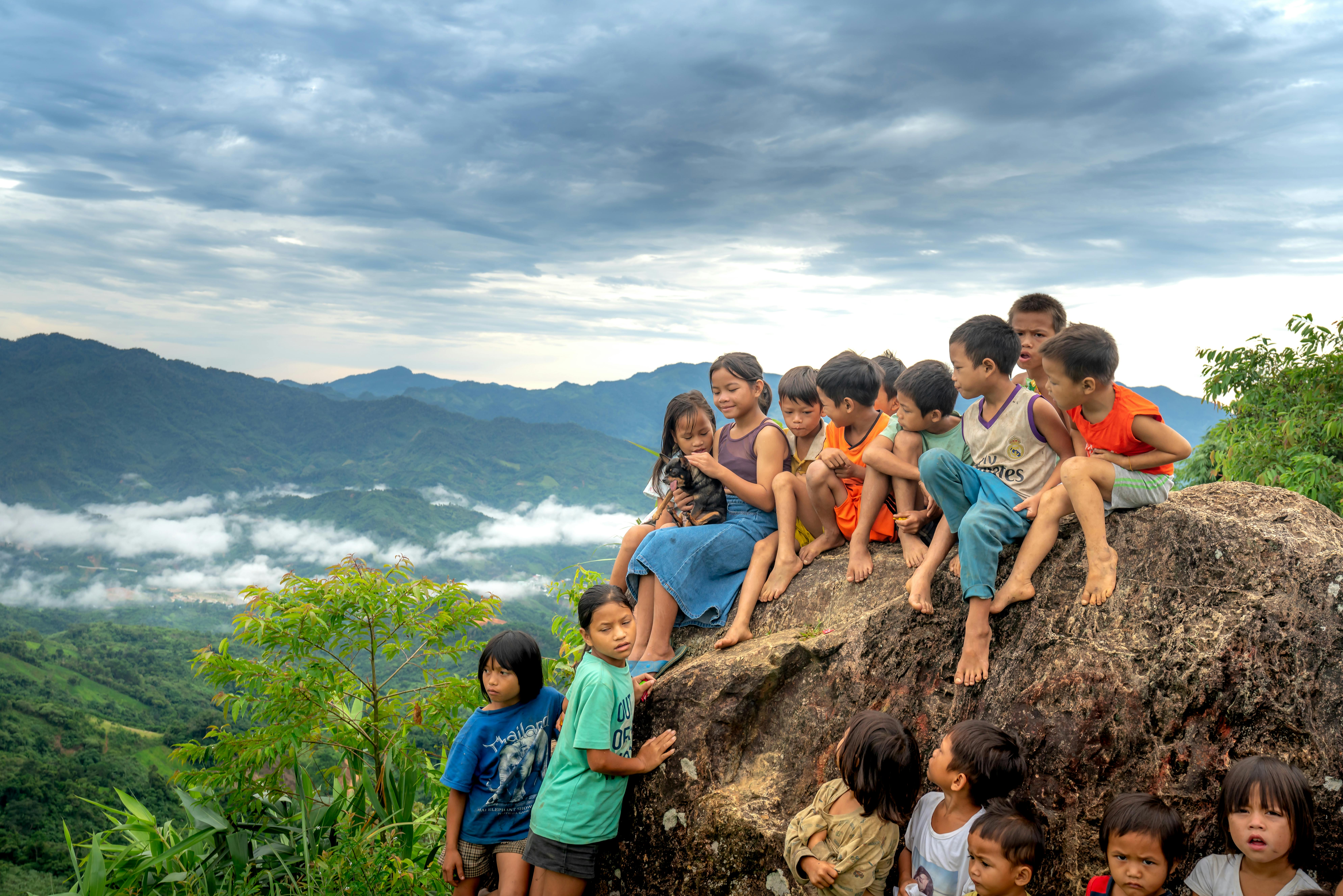 Group of Children sitting on the Big Rock · Free Stock Photo