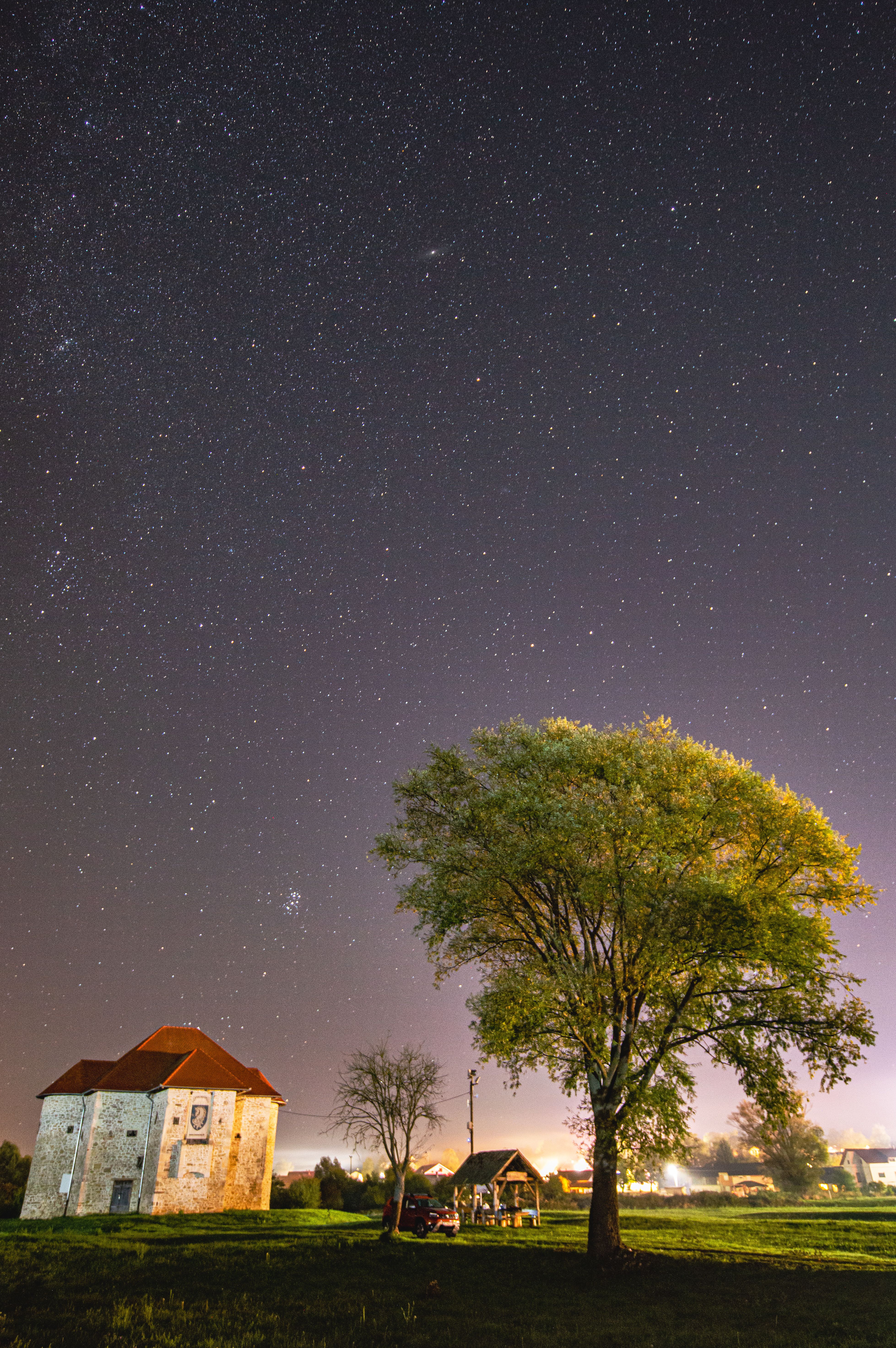 A Concrete House Near Green Tree Under Starry Sky · Free Stock Photo