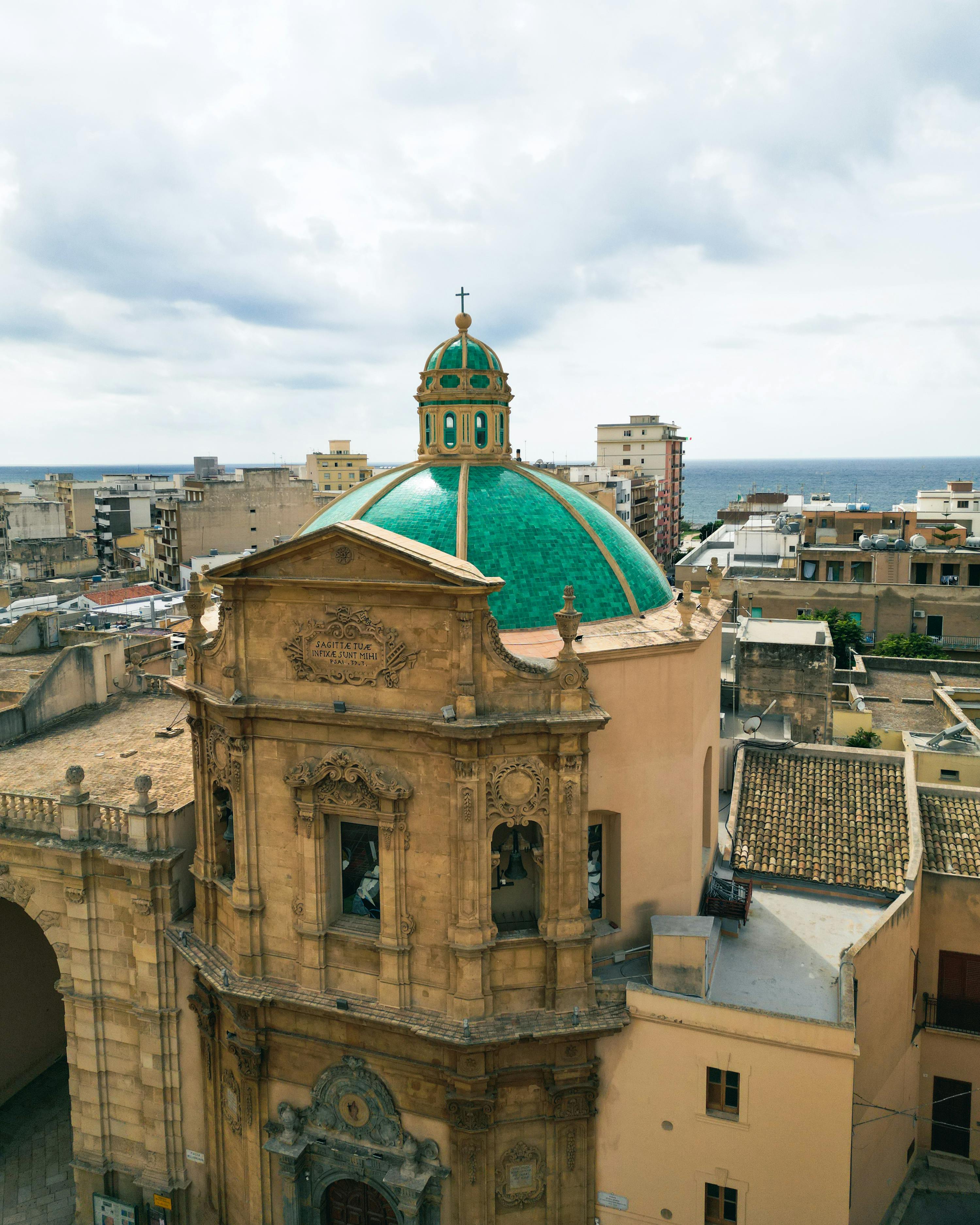 A Cathedral Near Concrete Buildings · Free Stock Photo