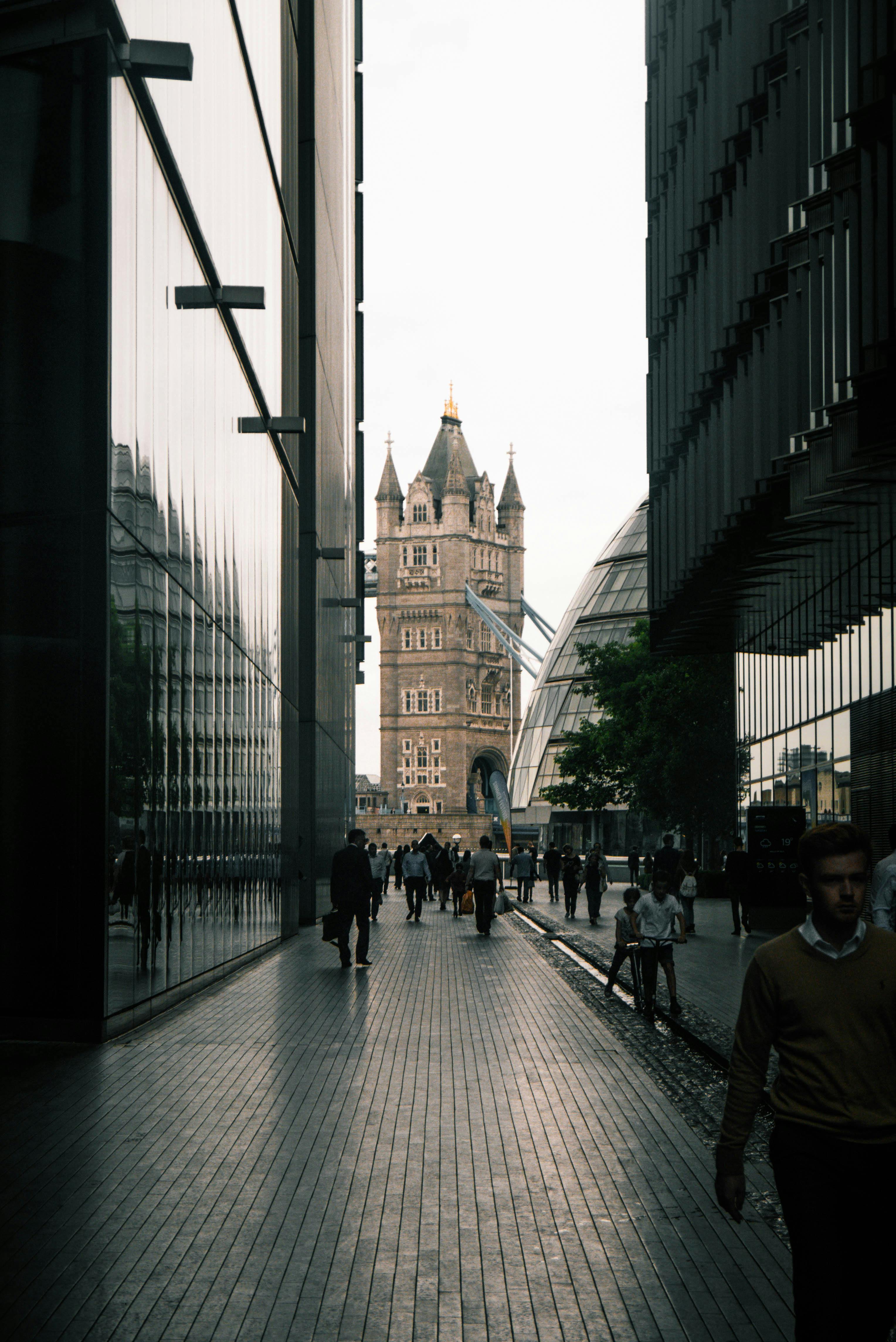 People Walking on Sidewalk Near High Rise Building · Free Stock Photo