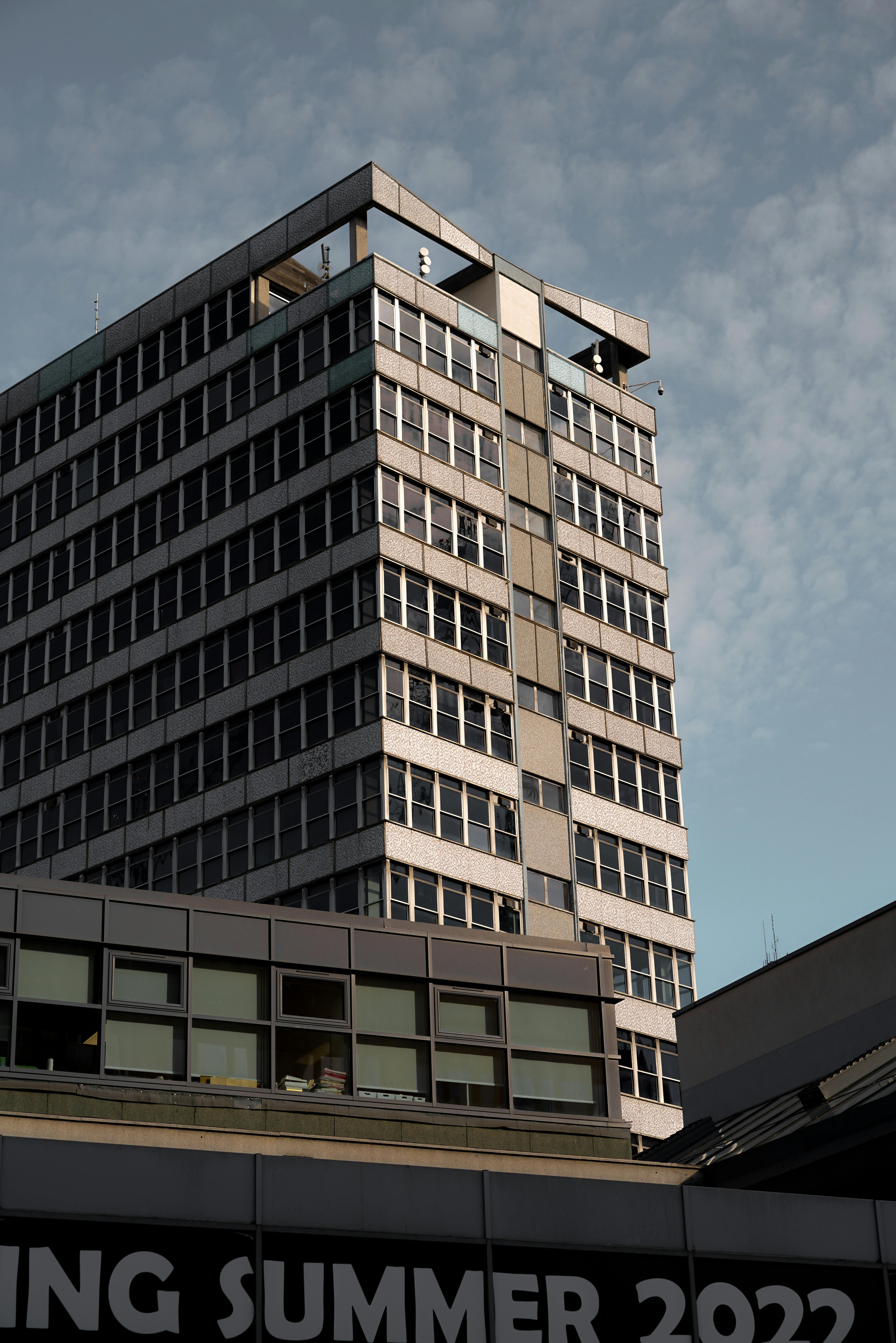 High Rise Concrete Building Under Blue Sky · Free Stock Photo