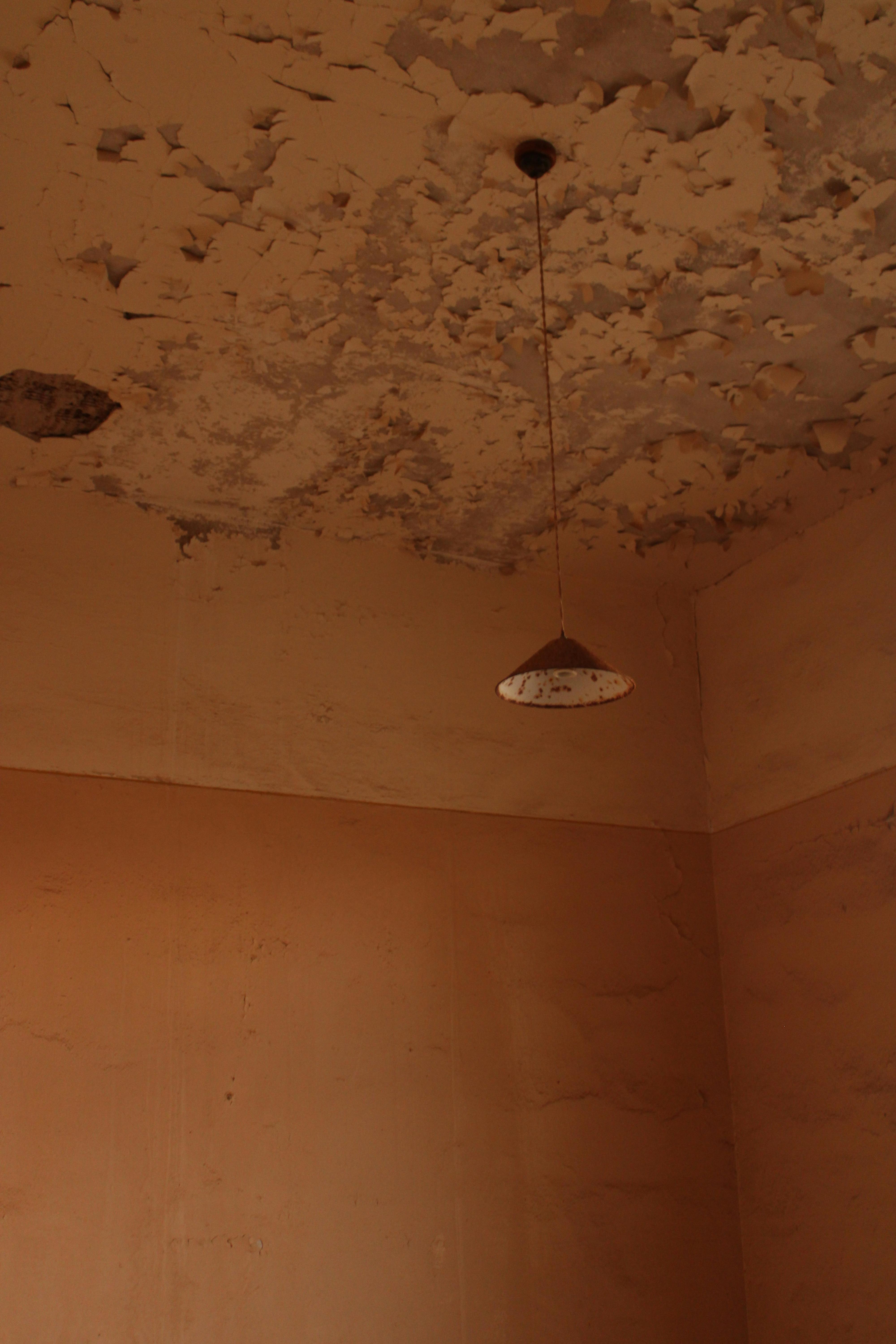 Lamp on Damaged Ceiling in Room Corner · Free Stock Photo