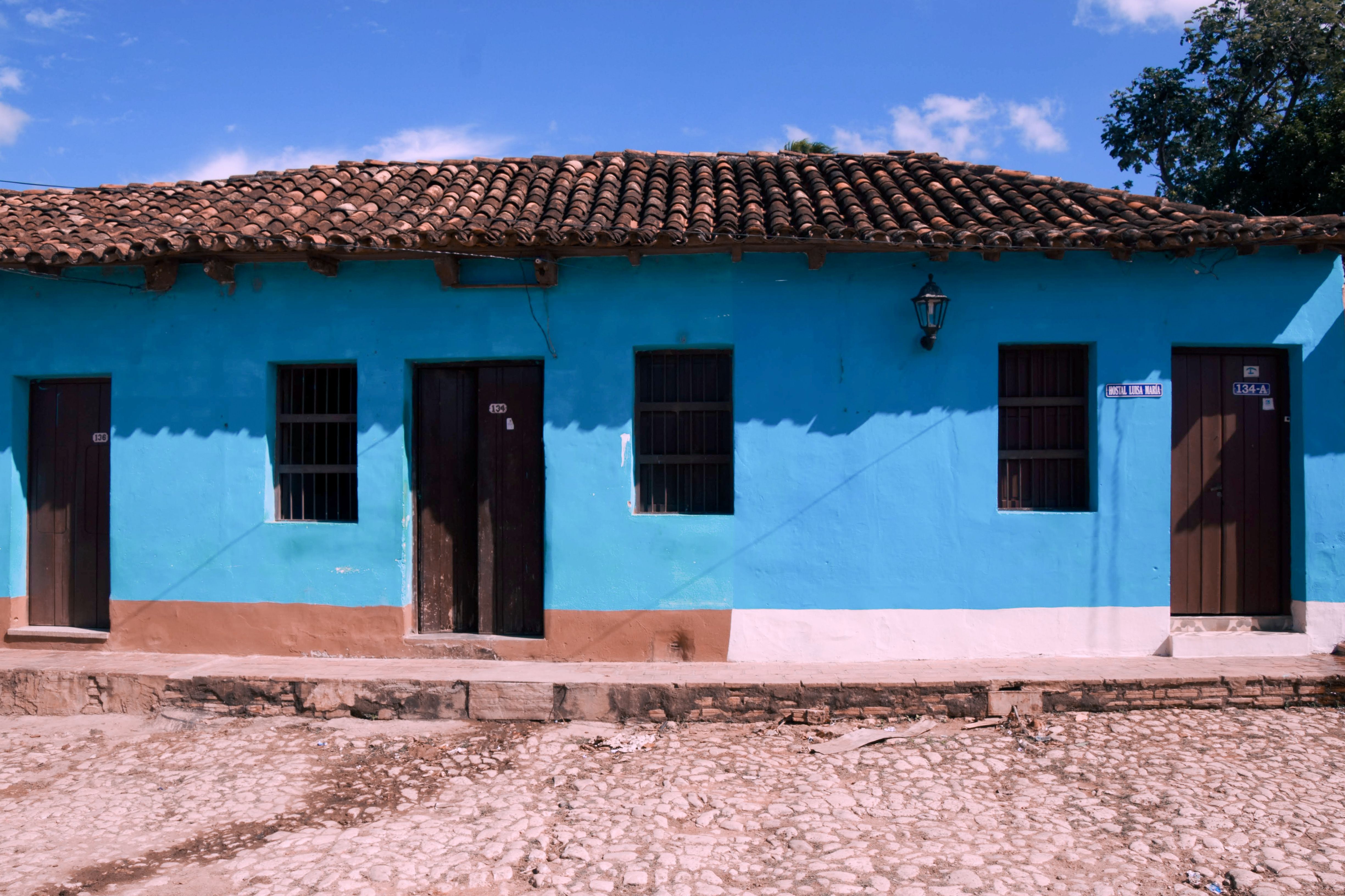 An Old Blue Concrete Building with Roof Tiles · Free Stock Photo
