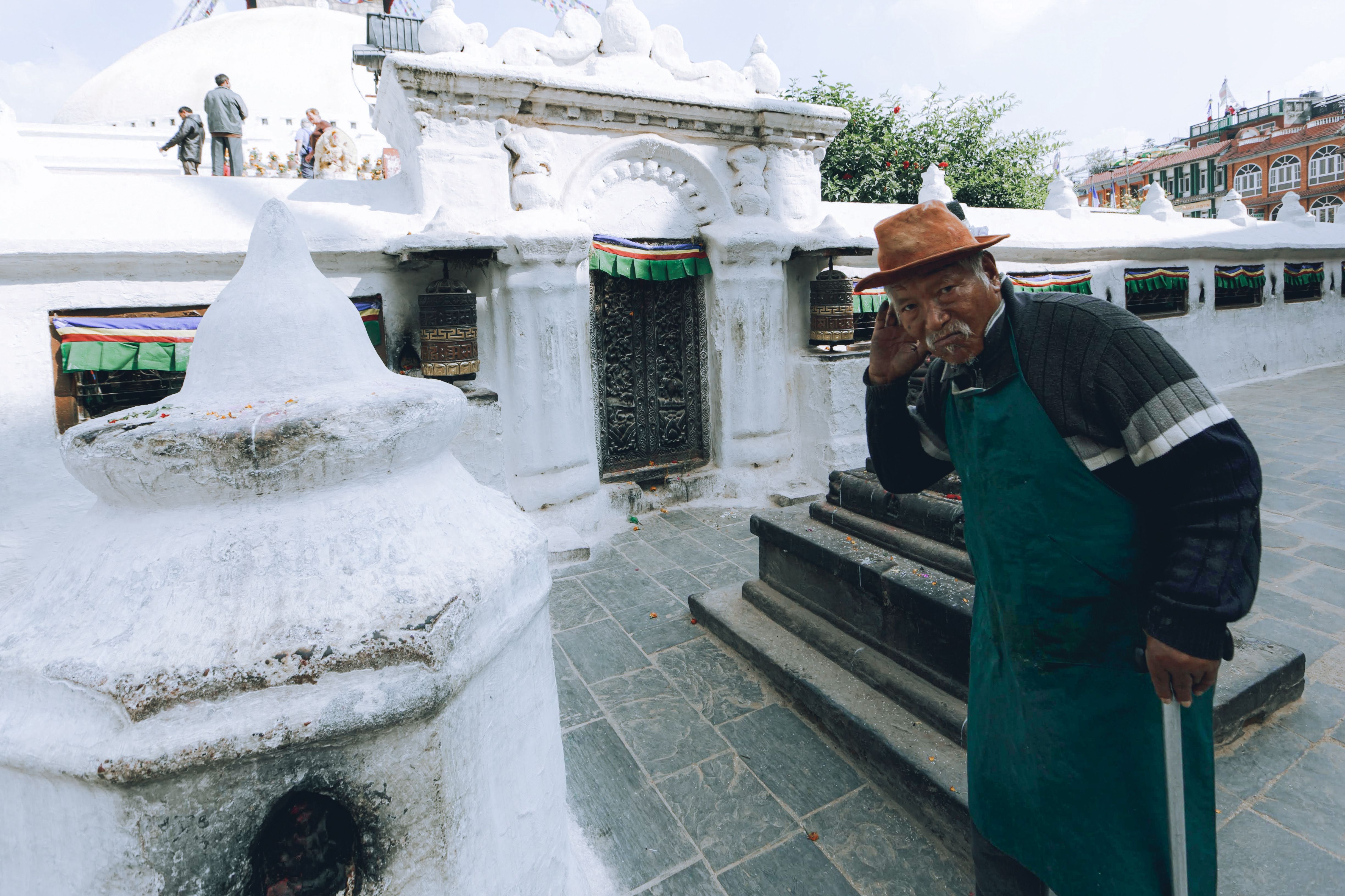 Man in Apron near Temple Entrance · Free Stock Photo