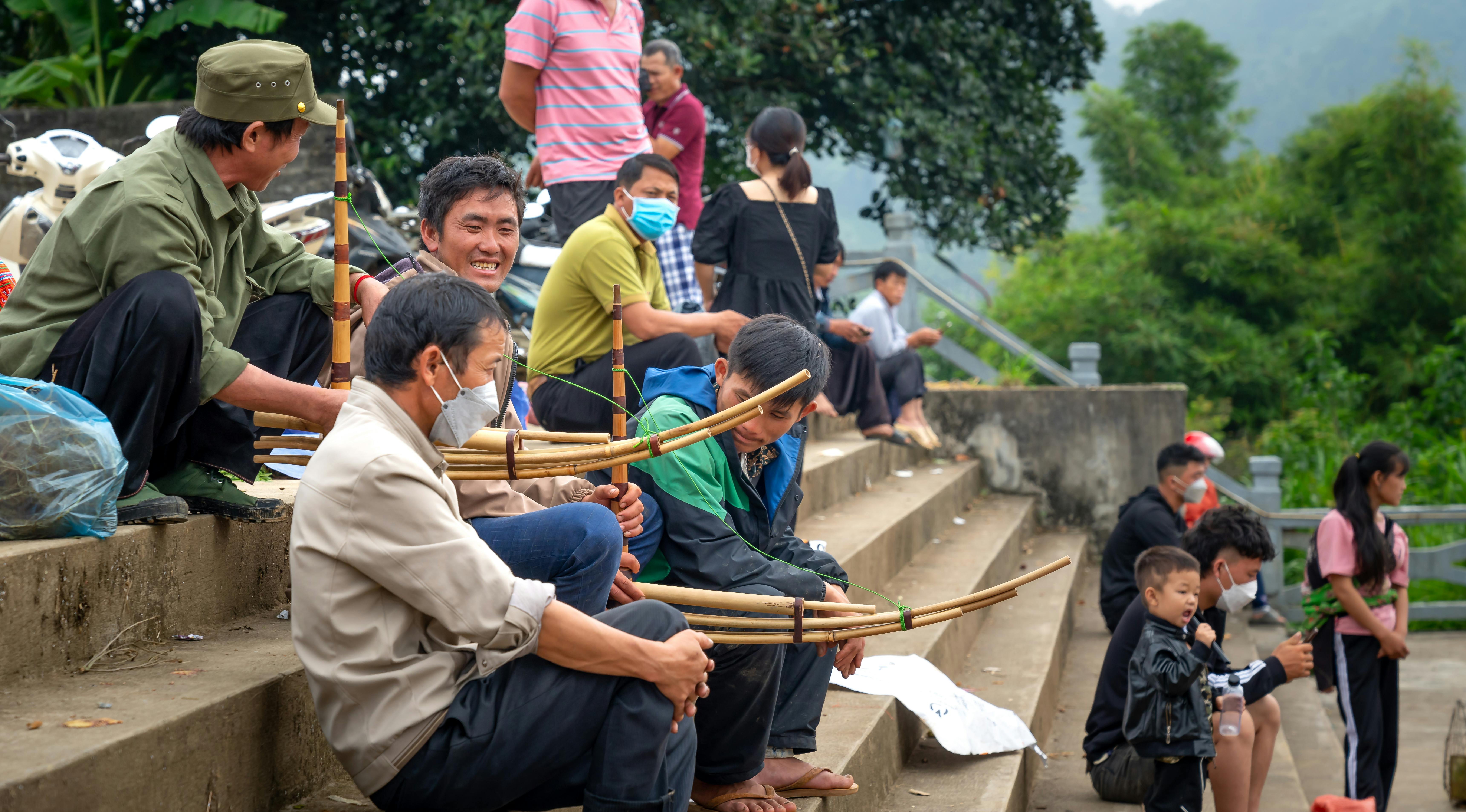 Smiling People Sitting on Steps · Free Stock Photo