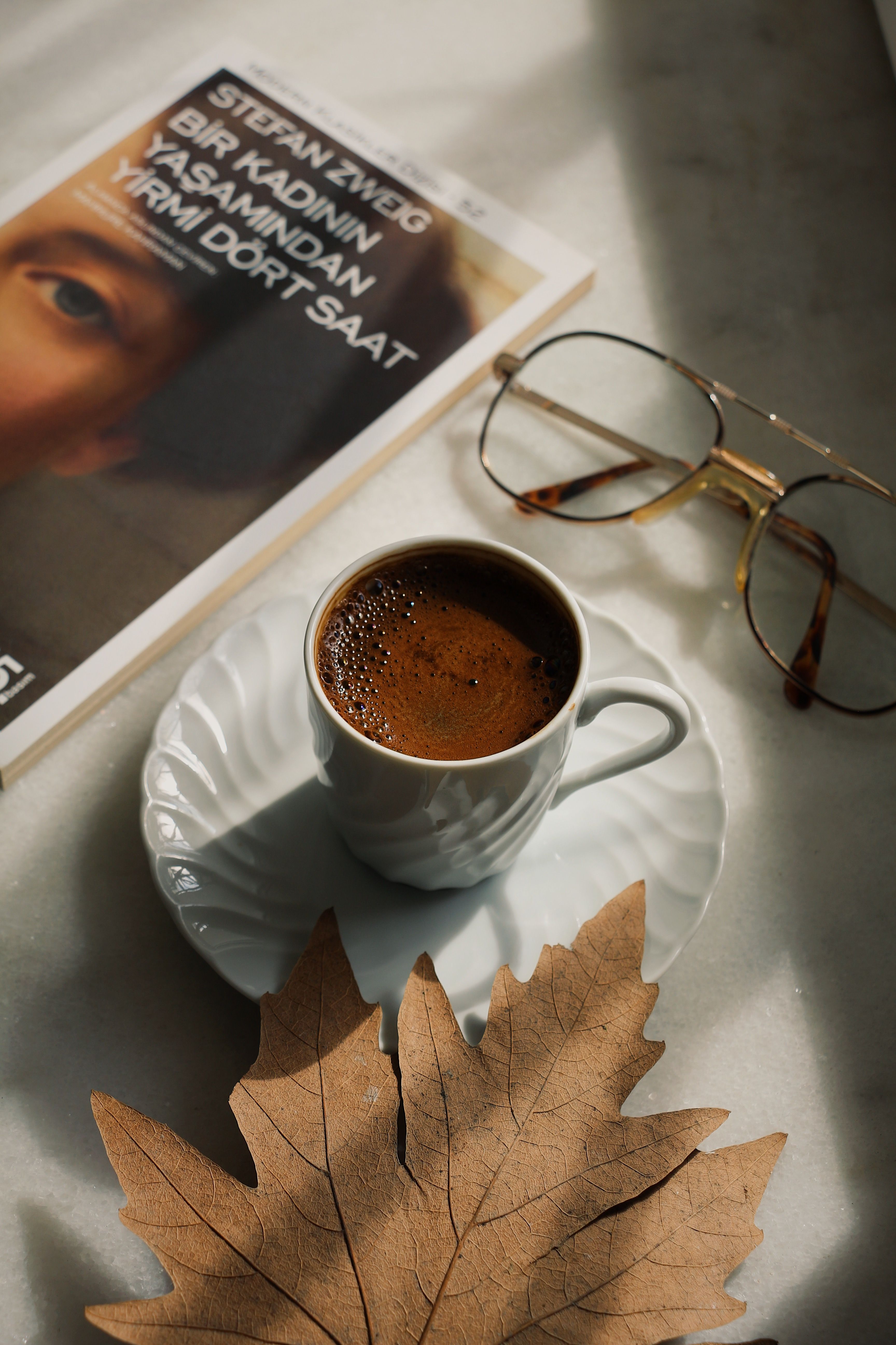 Coffee Cup, Leaf, Eyeglasses and Book · Free Stock Photo