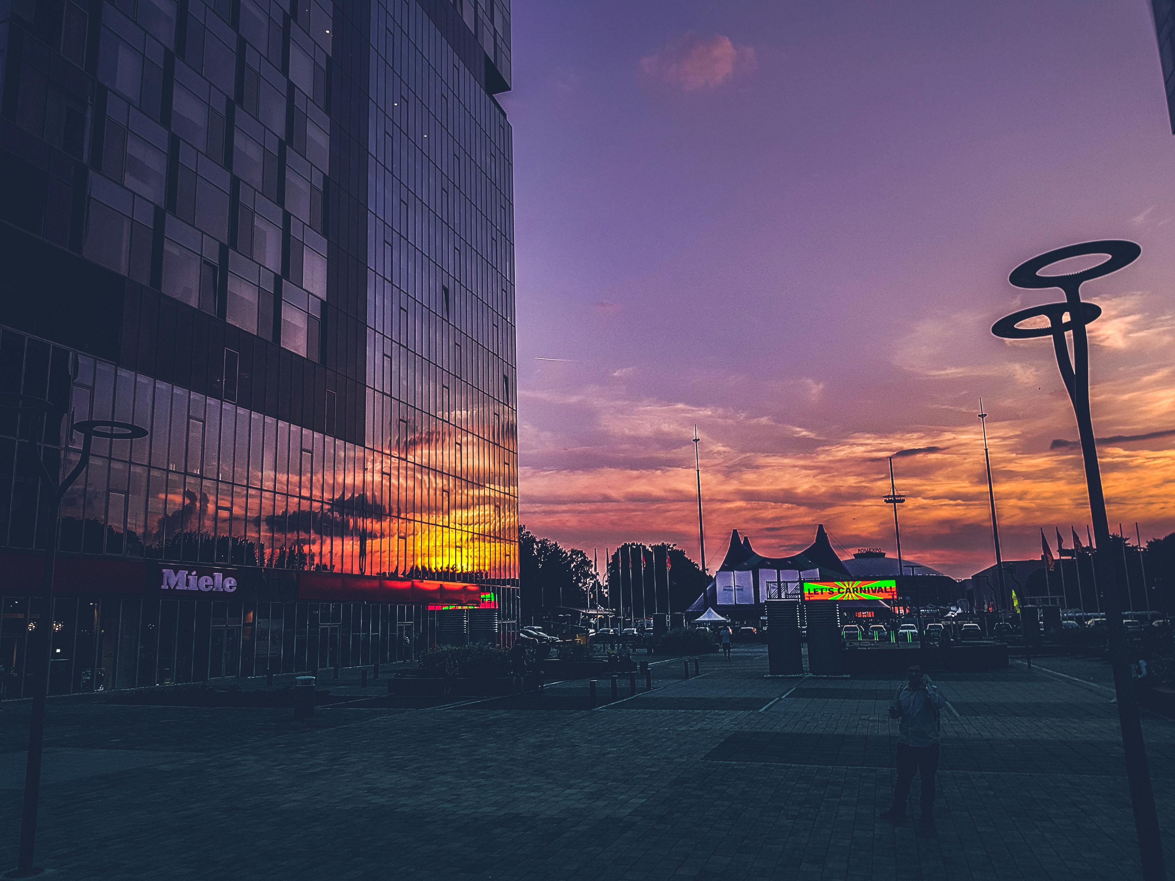 Person Standing Outside High-rise Building at Golden Hour · Free Stock ...