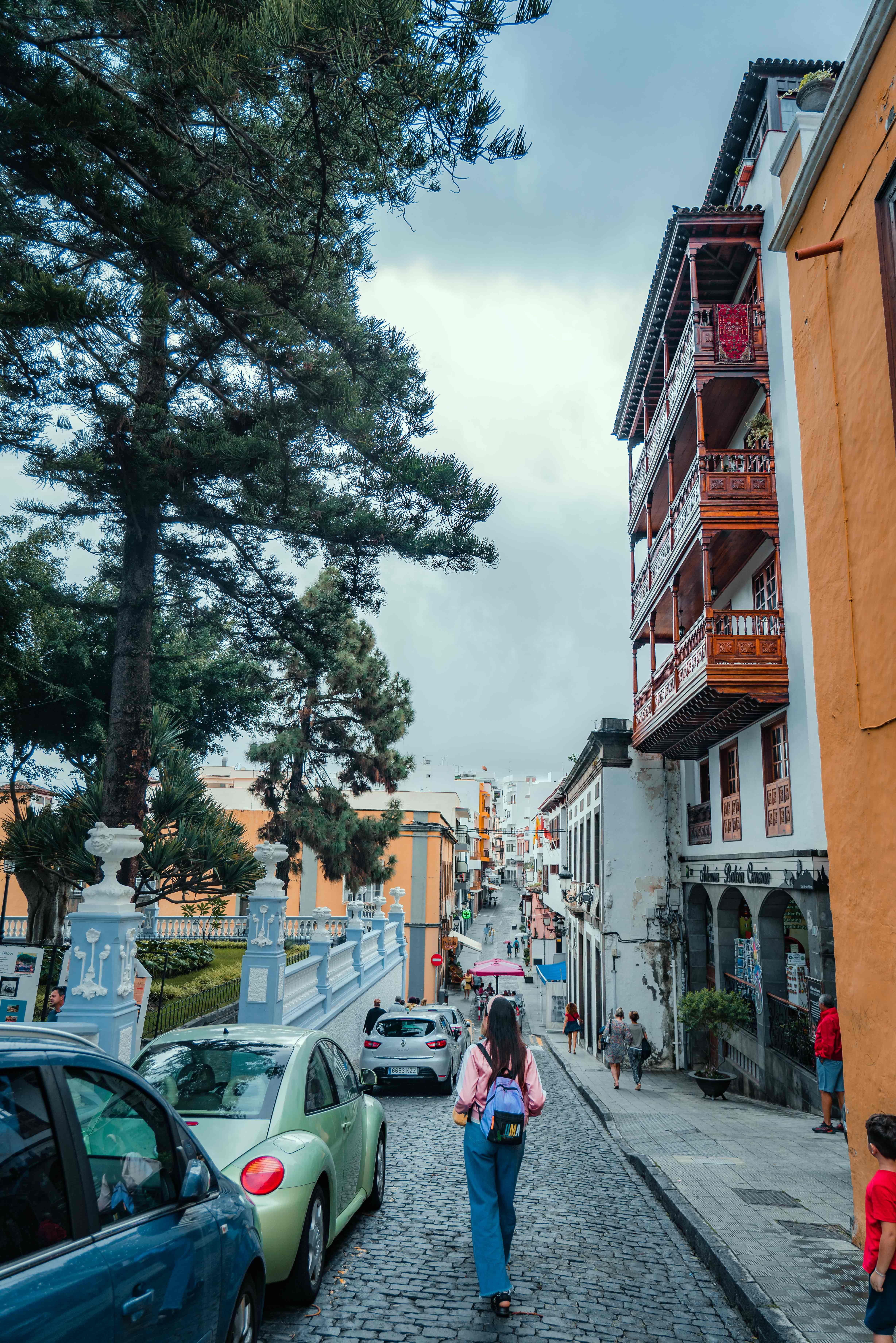 Woman Walking on Street Beside Parked Cars · Free Stock Photo