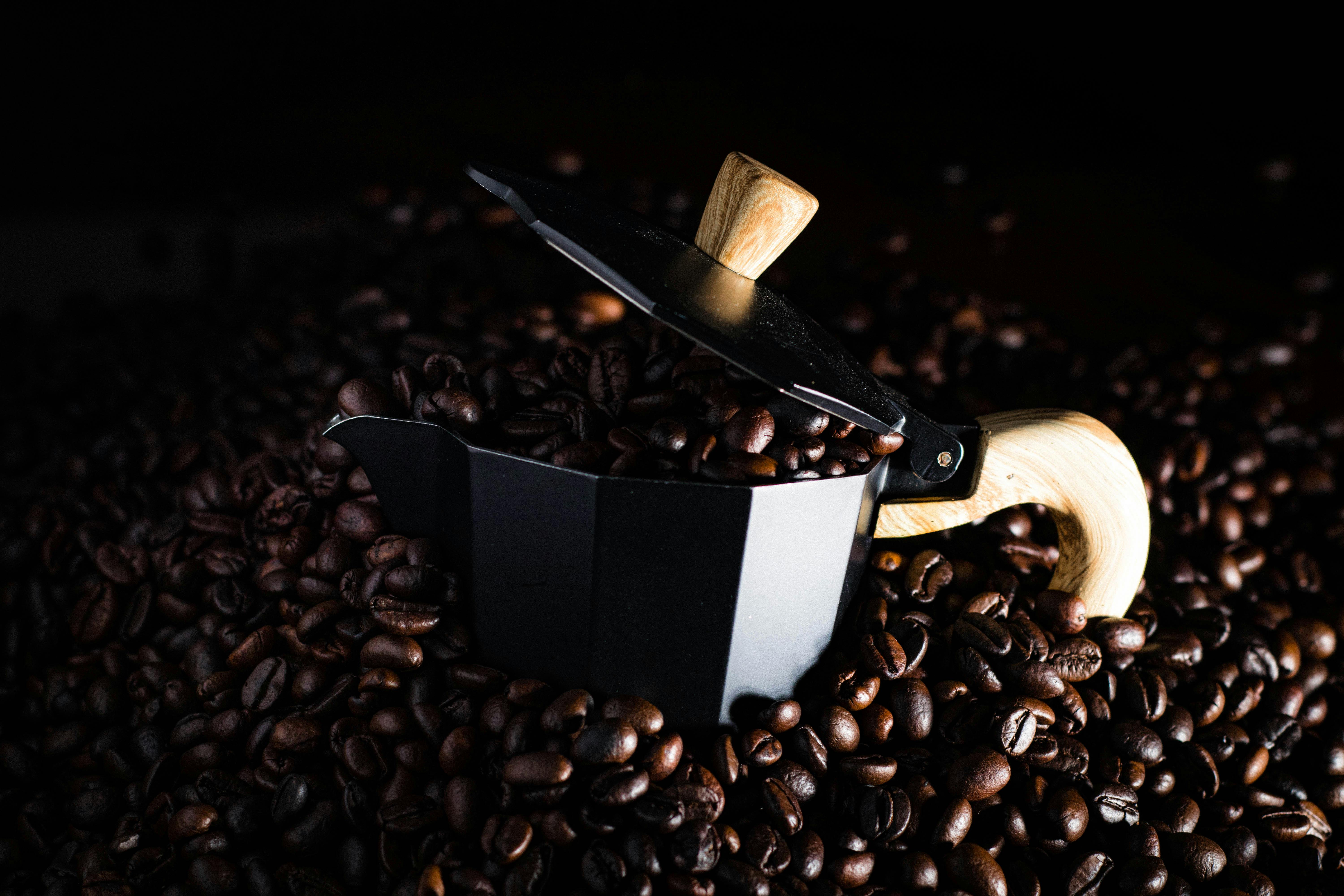 Close-Up Photograph of a Moka Pot with Coffee Beans · Free Stock Photo
