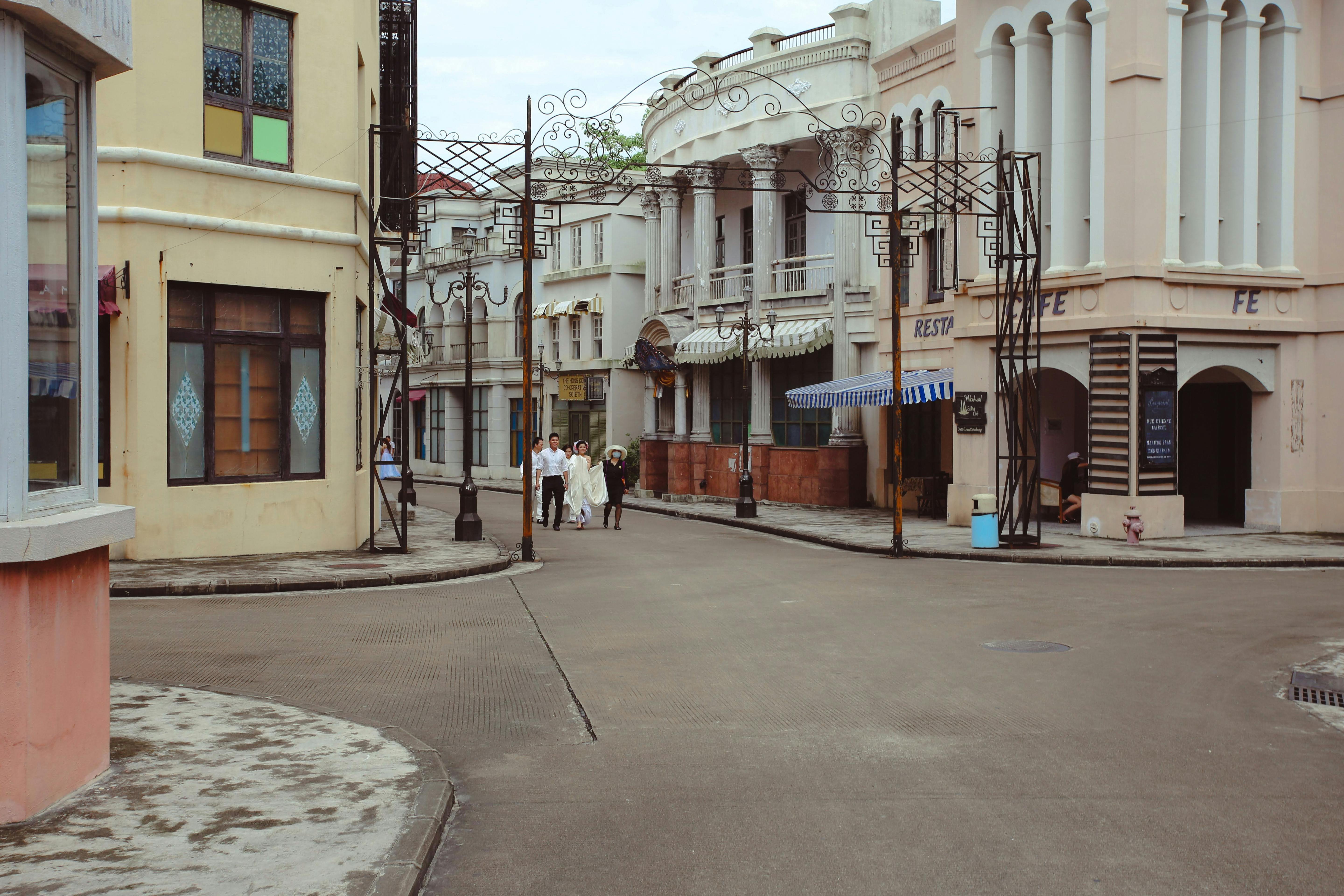 People Walking on the Street Near White Building · Free Stock Photo