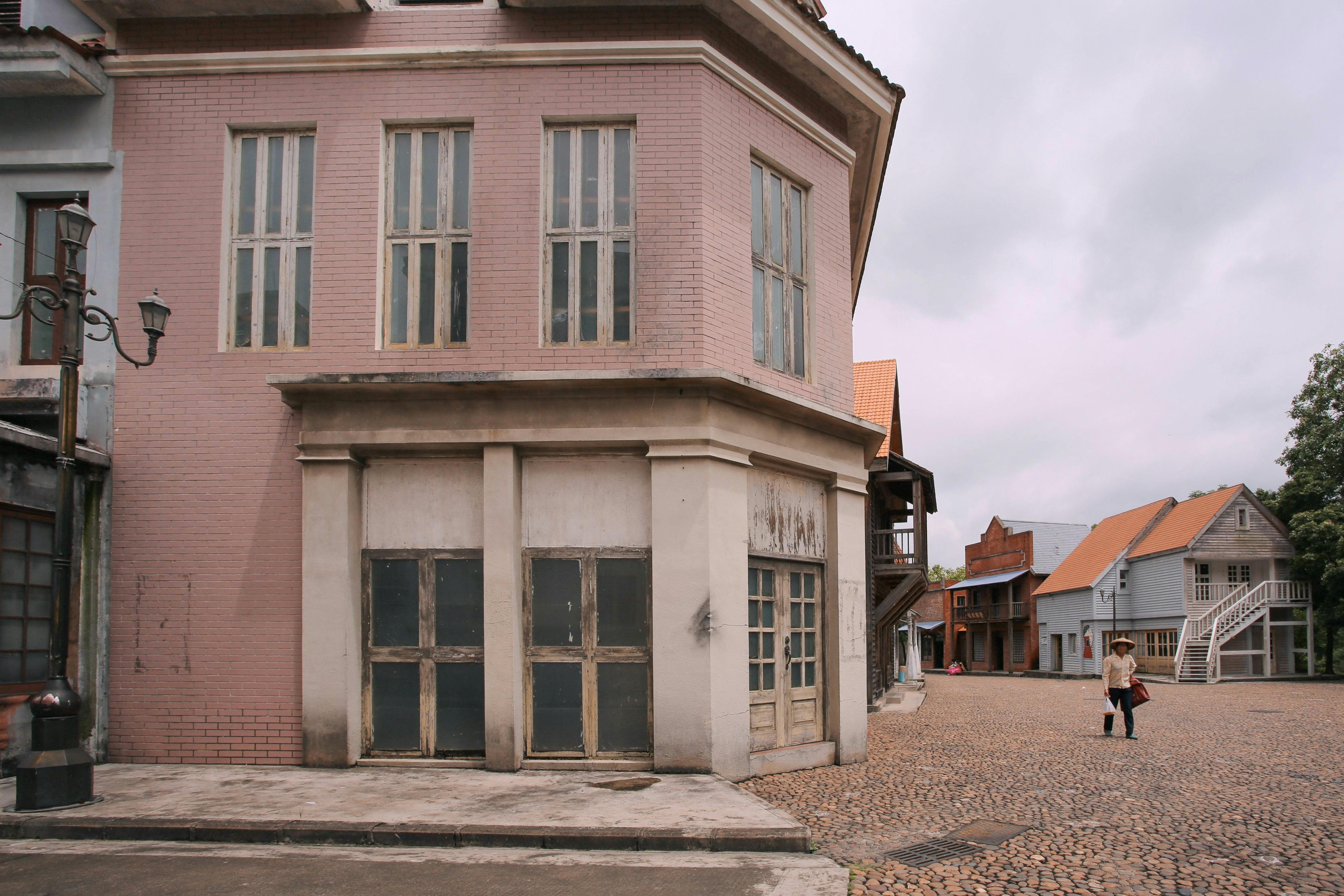 Person Walking in front of Building · Free Stock Photo