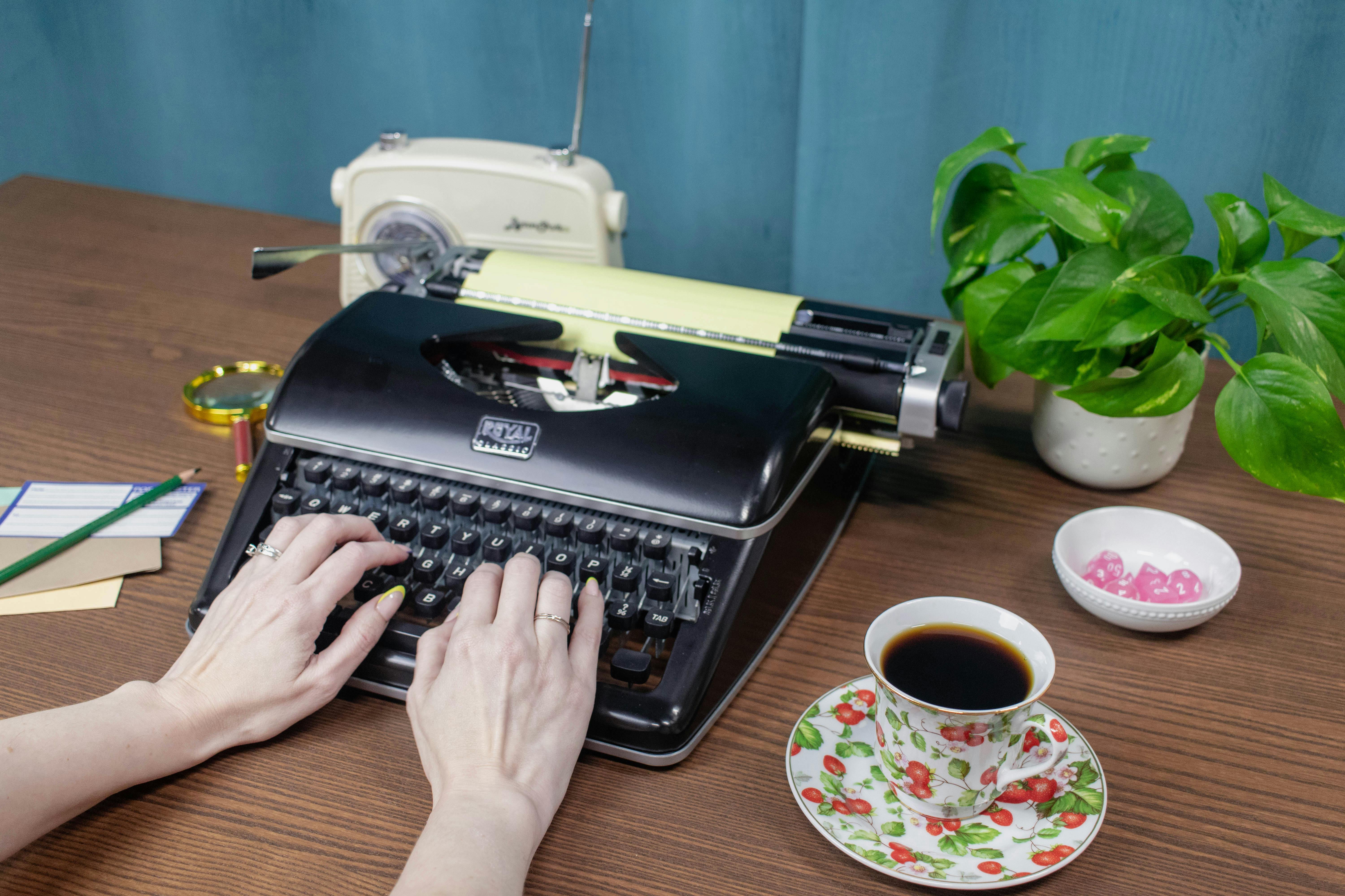 Person Using a Vintage Typewriter · Free Stock Photo