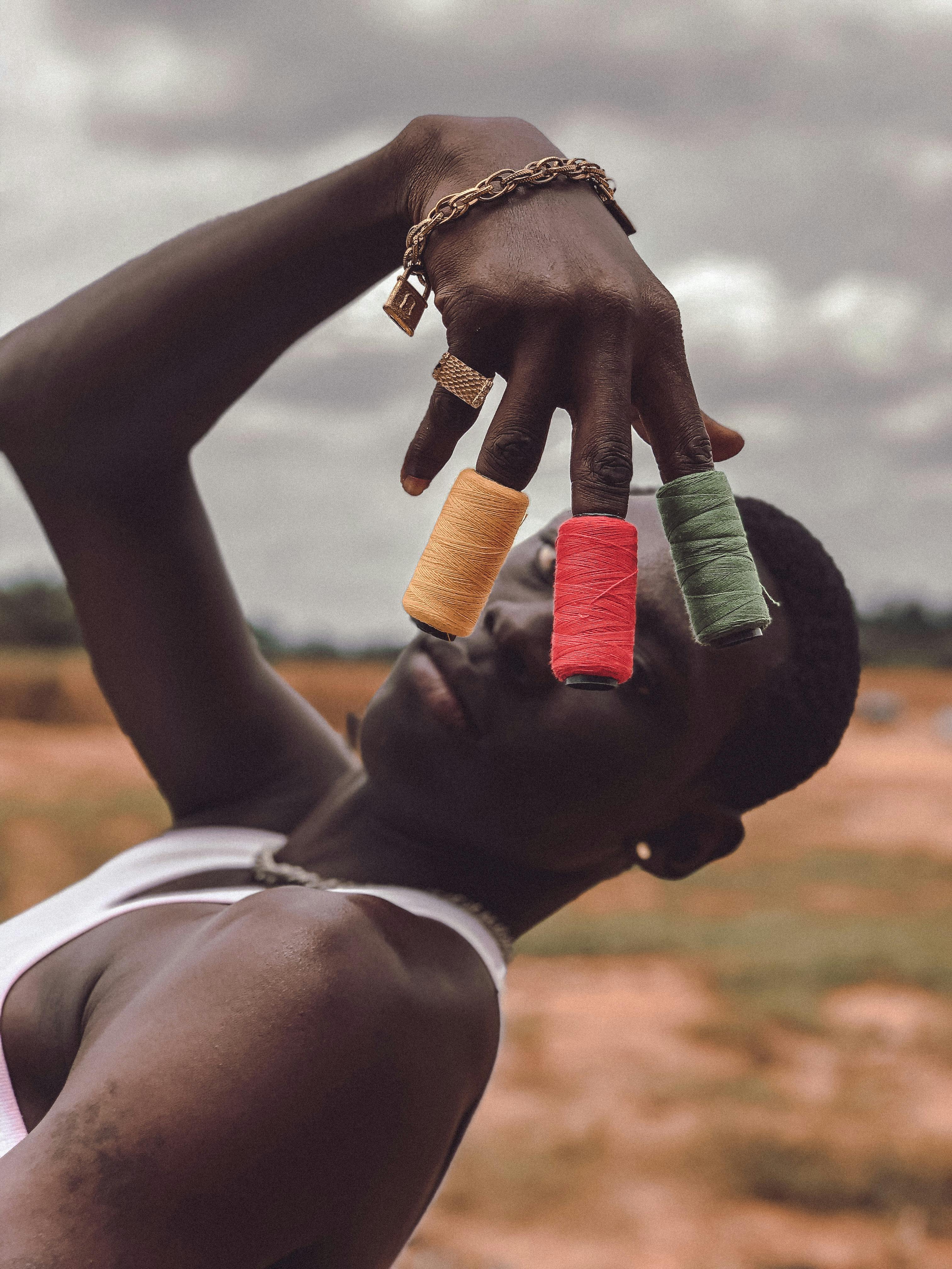 A Man with Colorful Threads on His Finger · Free Stock Photo