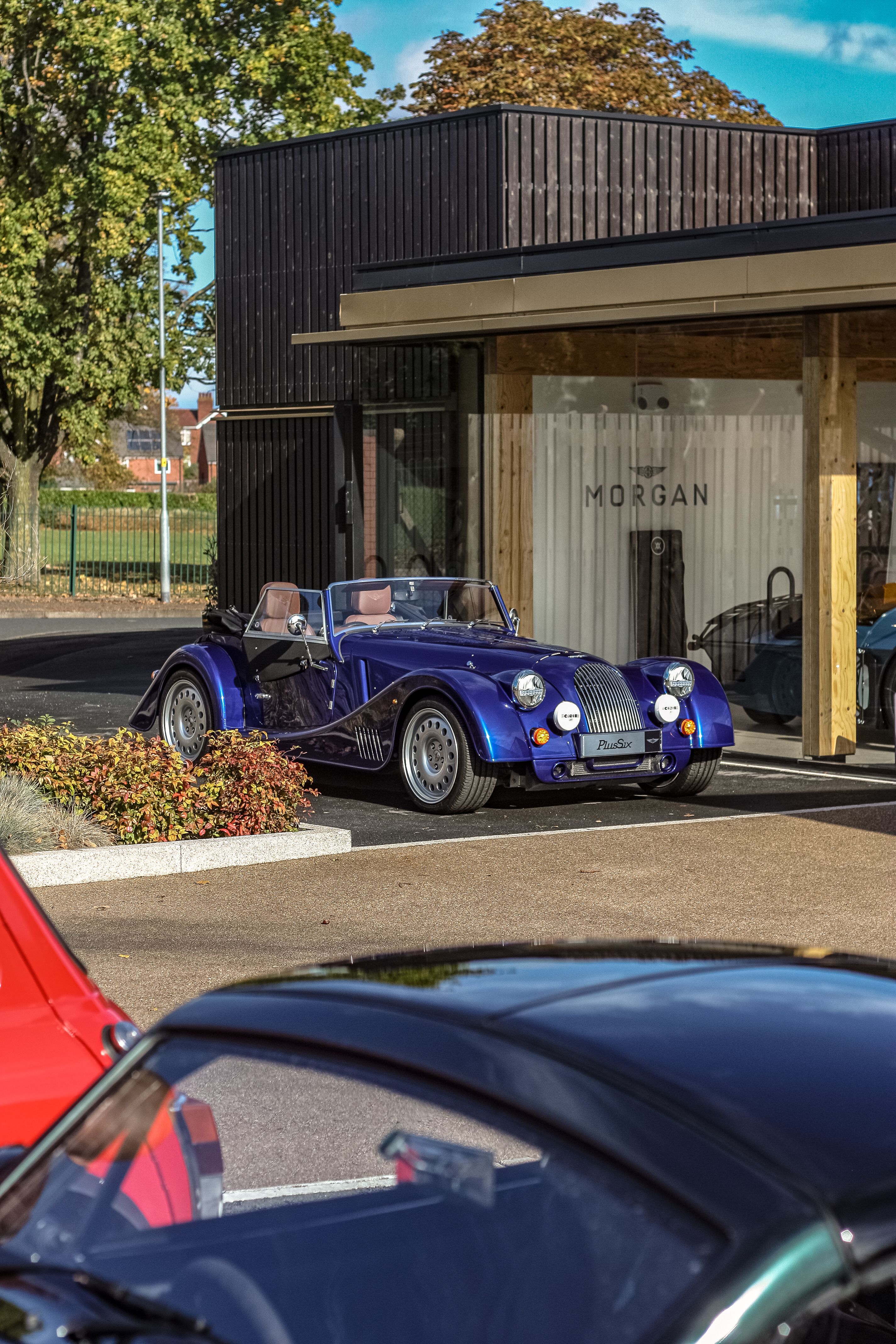 Vintage Blue Car in Front of a Display Window · Free Stock Photo