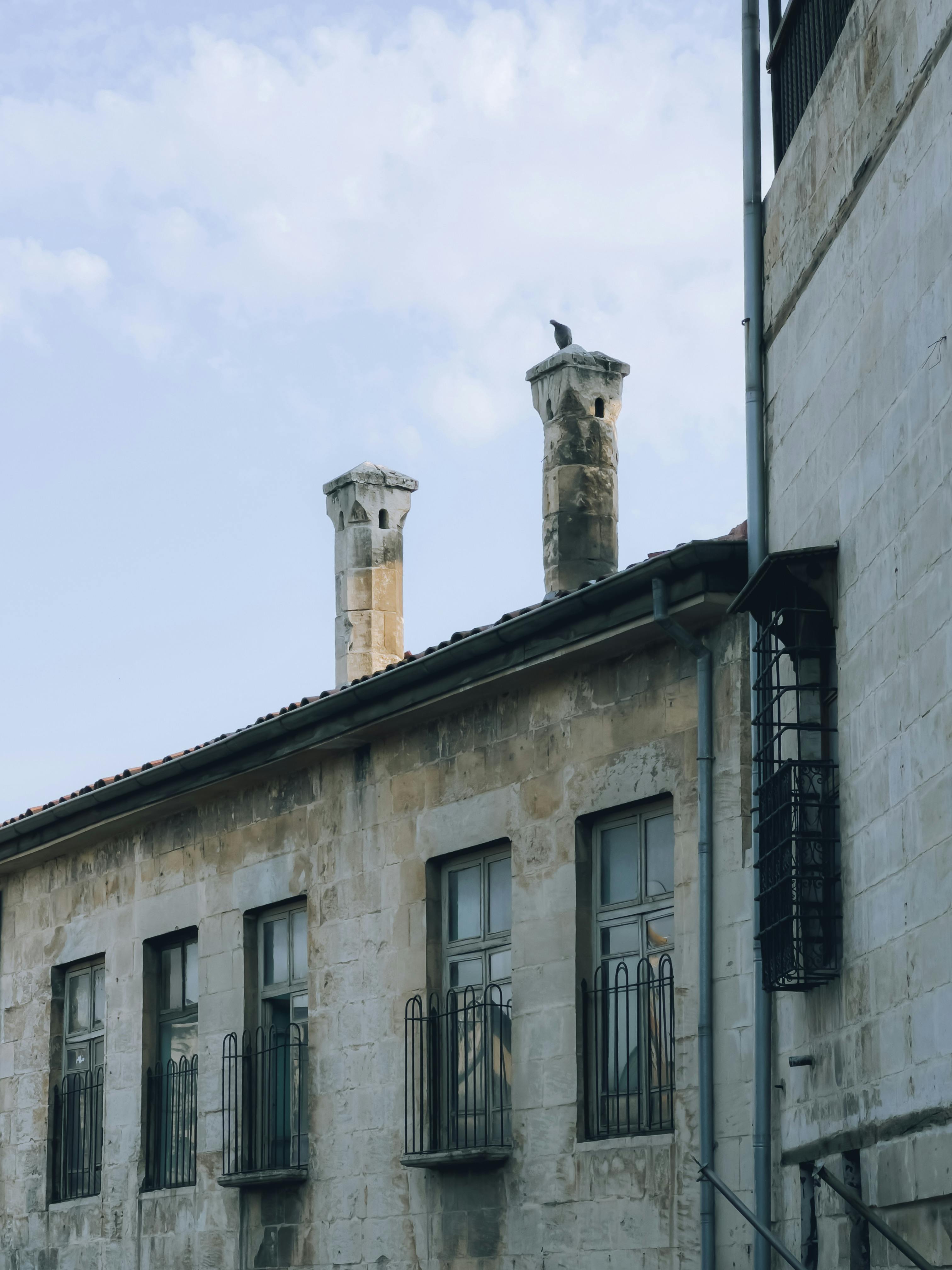 Old Concrete Building with Balconies Under White Sky · Free Stock Photo