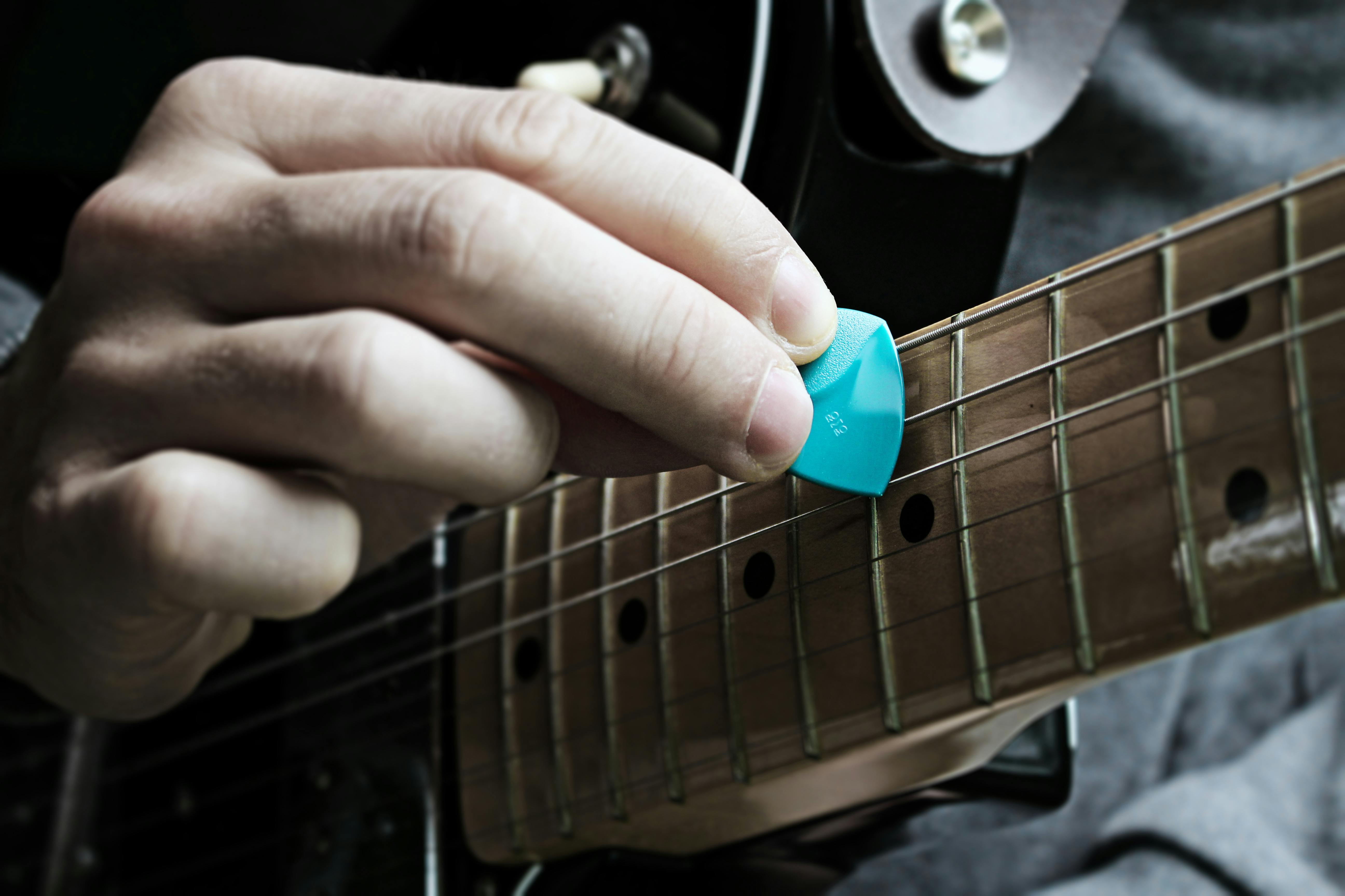 Guitar Pick laying on Fret Board and Guitar Gear · Free Stock Photo