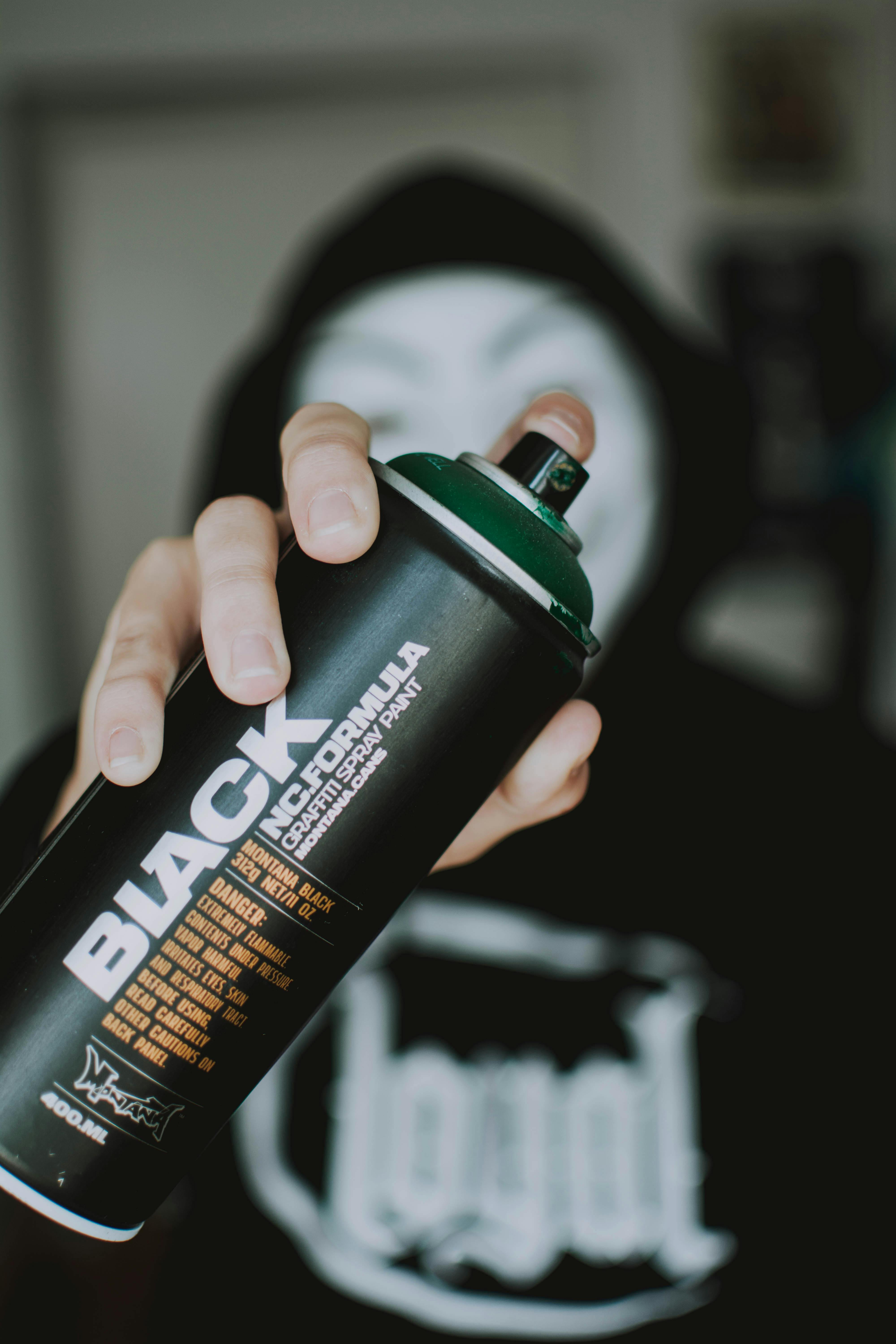 Person Holding Black Spray Bottle · Free Stock Photo
