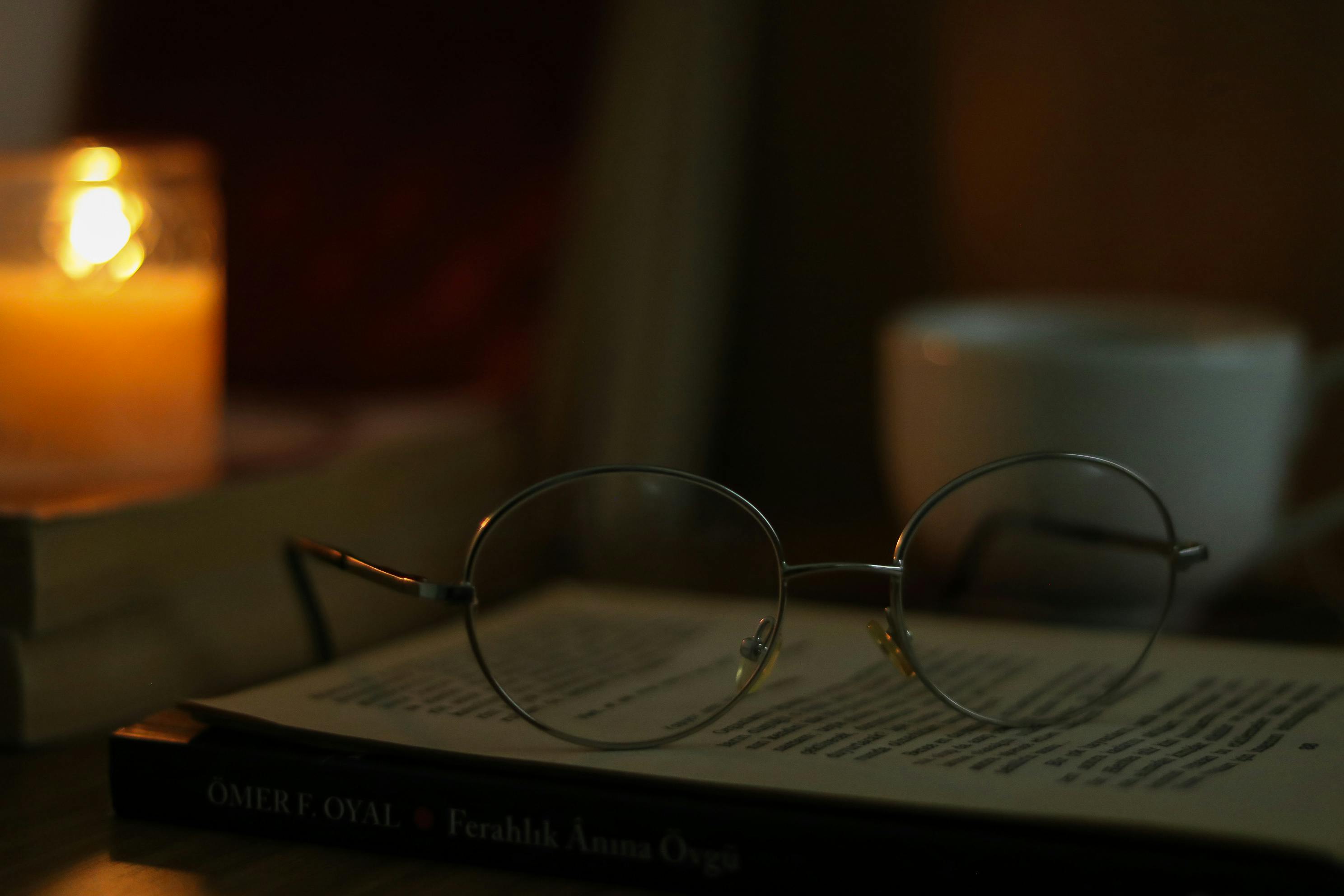 Eyeglasses on Top of a Book · Free Stock Photo