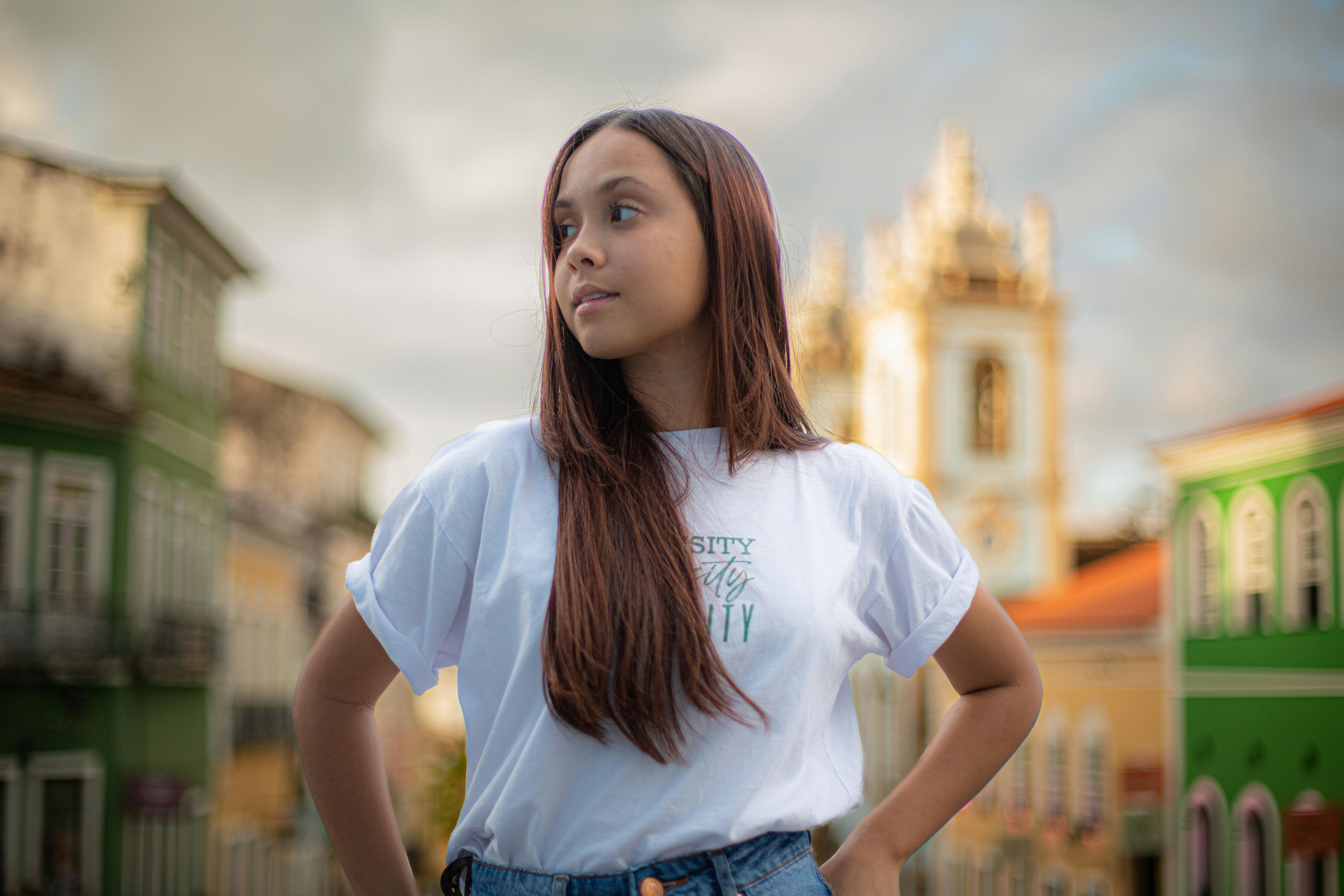 Woman in Black Shirt Leaning on a Pole · Free Stock Photo