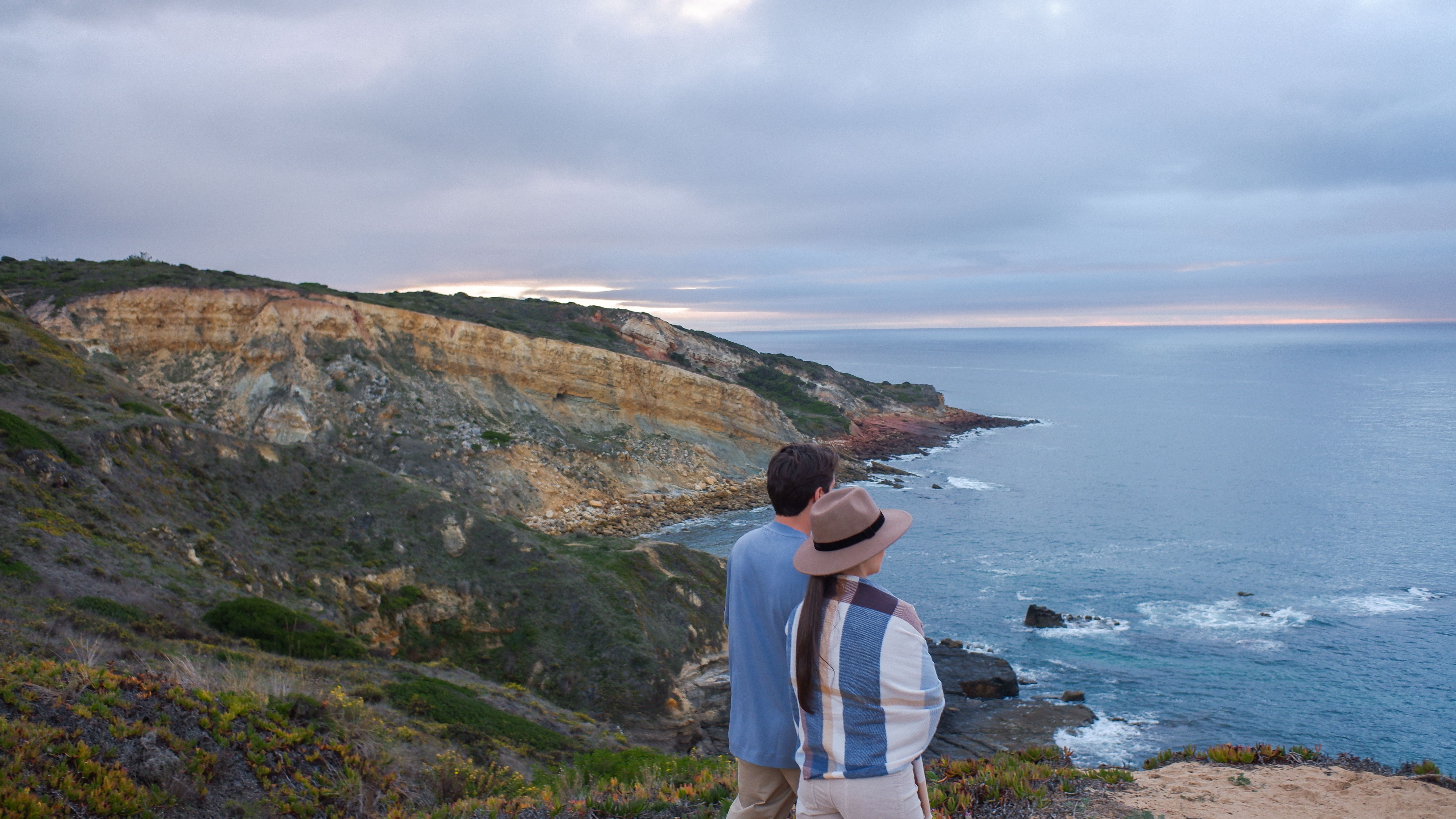 Man in White T-shirt Standing on Cliff Near Body of Water · Free Stock ...