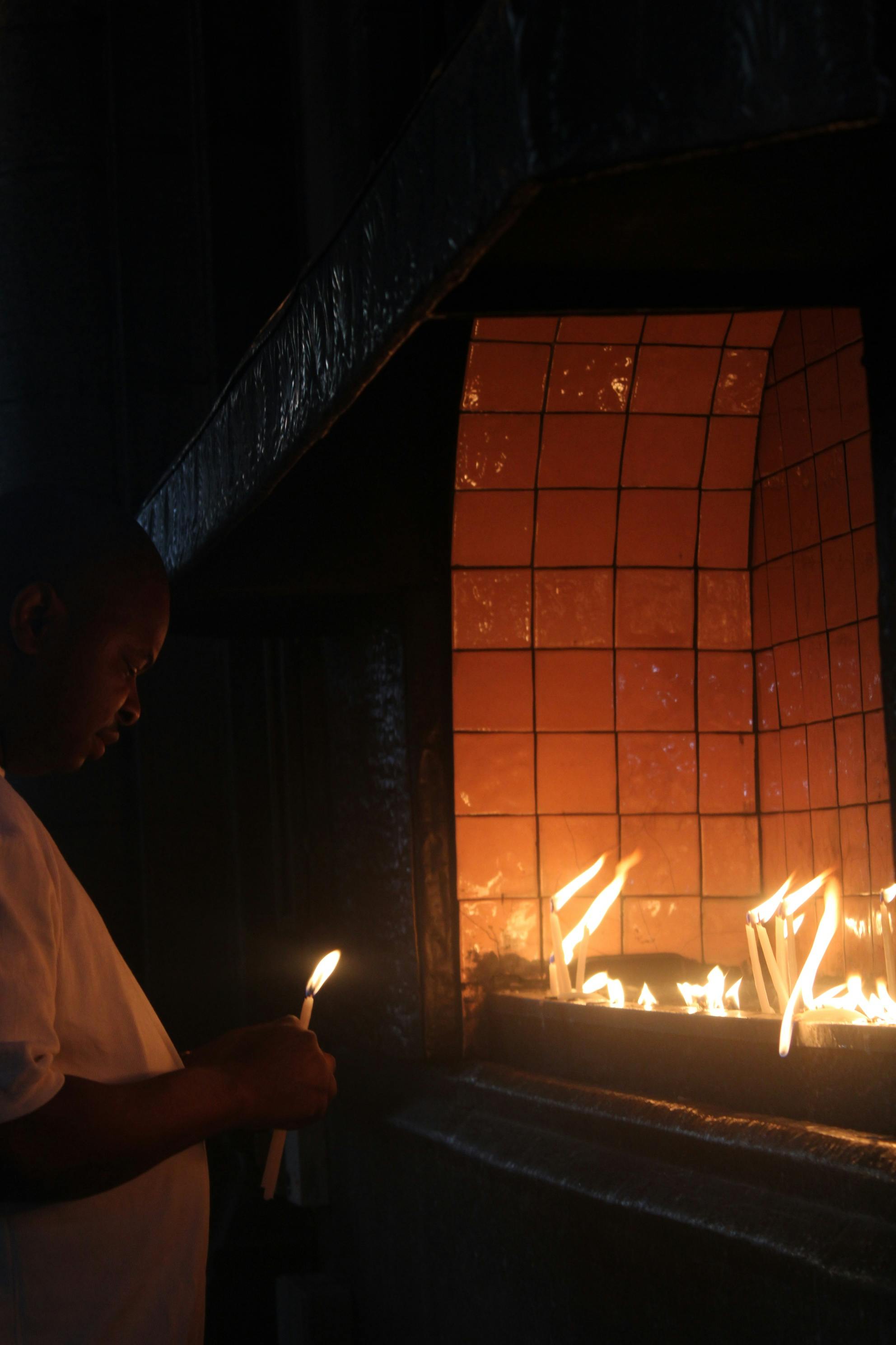 Person Holding Red Candle in a Dark Room · Free Stock Photo
