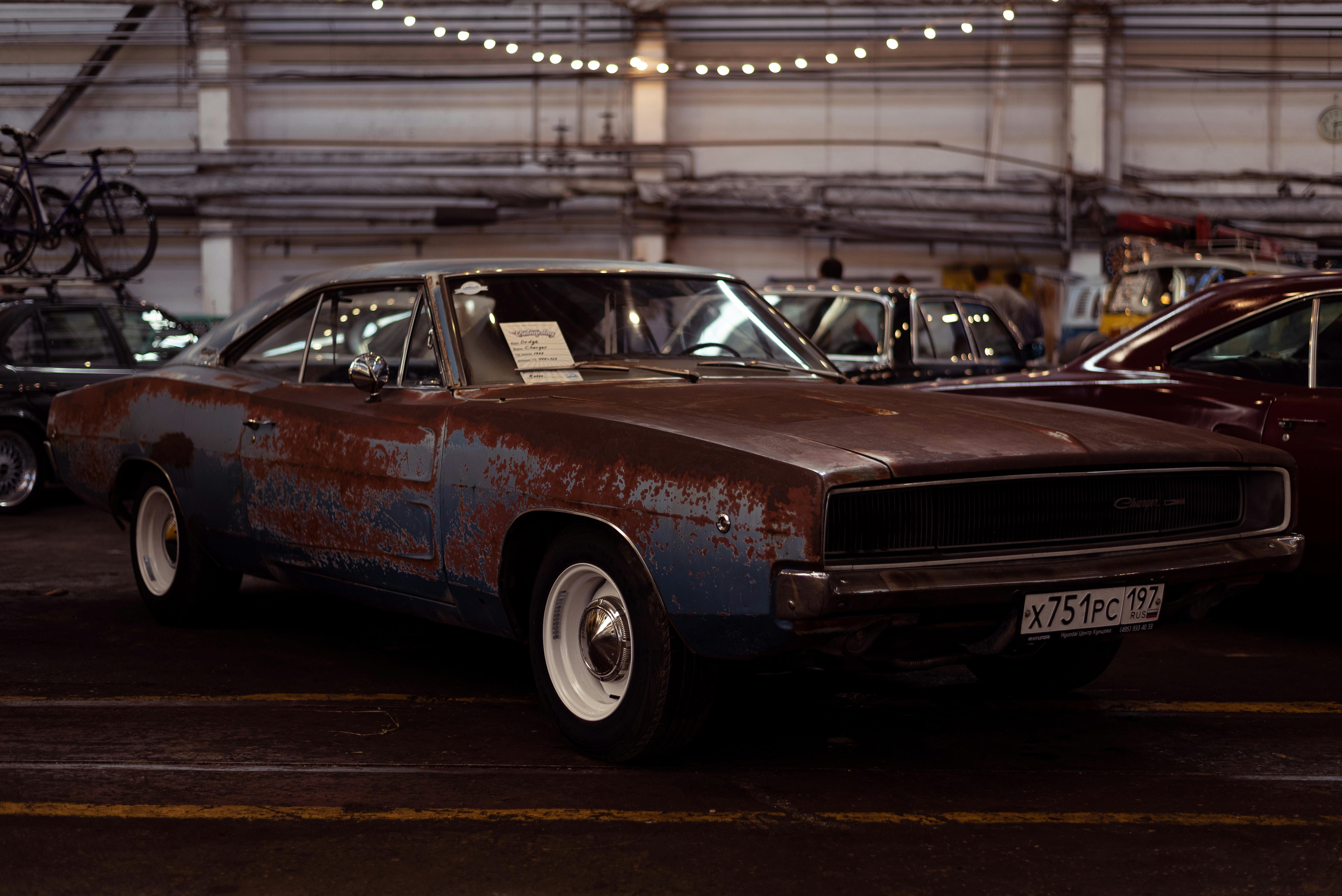 Rusty Muscle Car Parked at a Parking Garage · Free Stock Photo