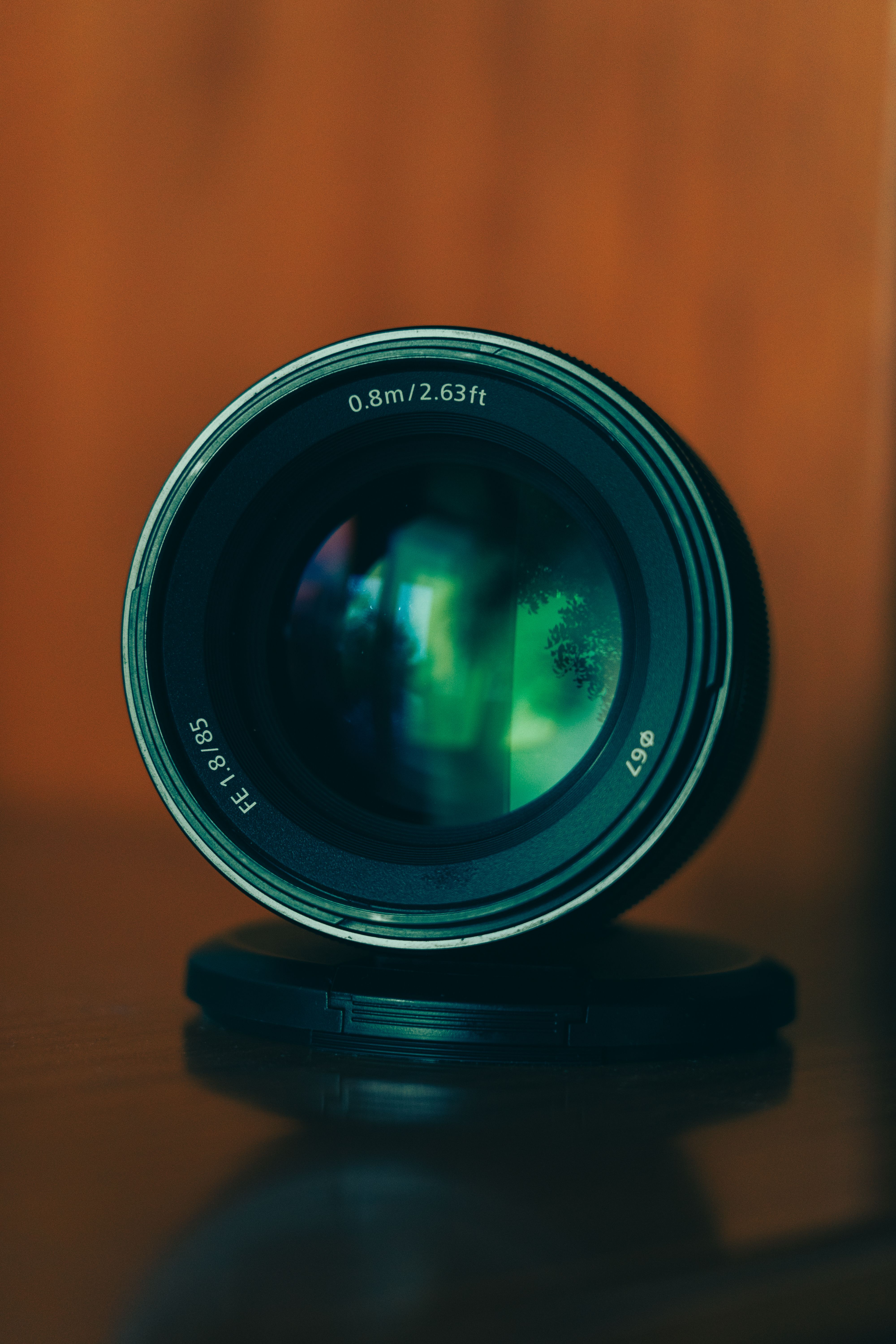 Black Camera Lens on a Brown Surface · Free Stock Photo