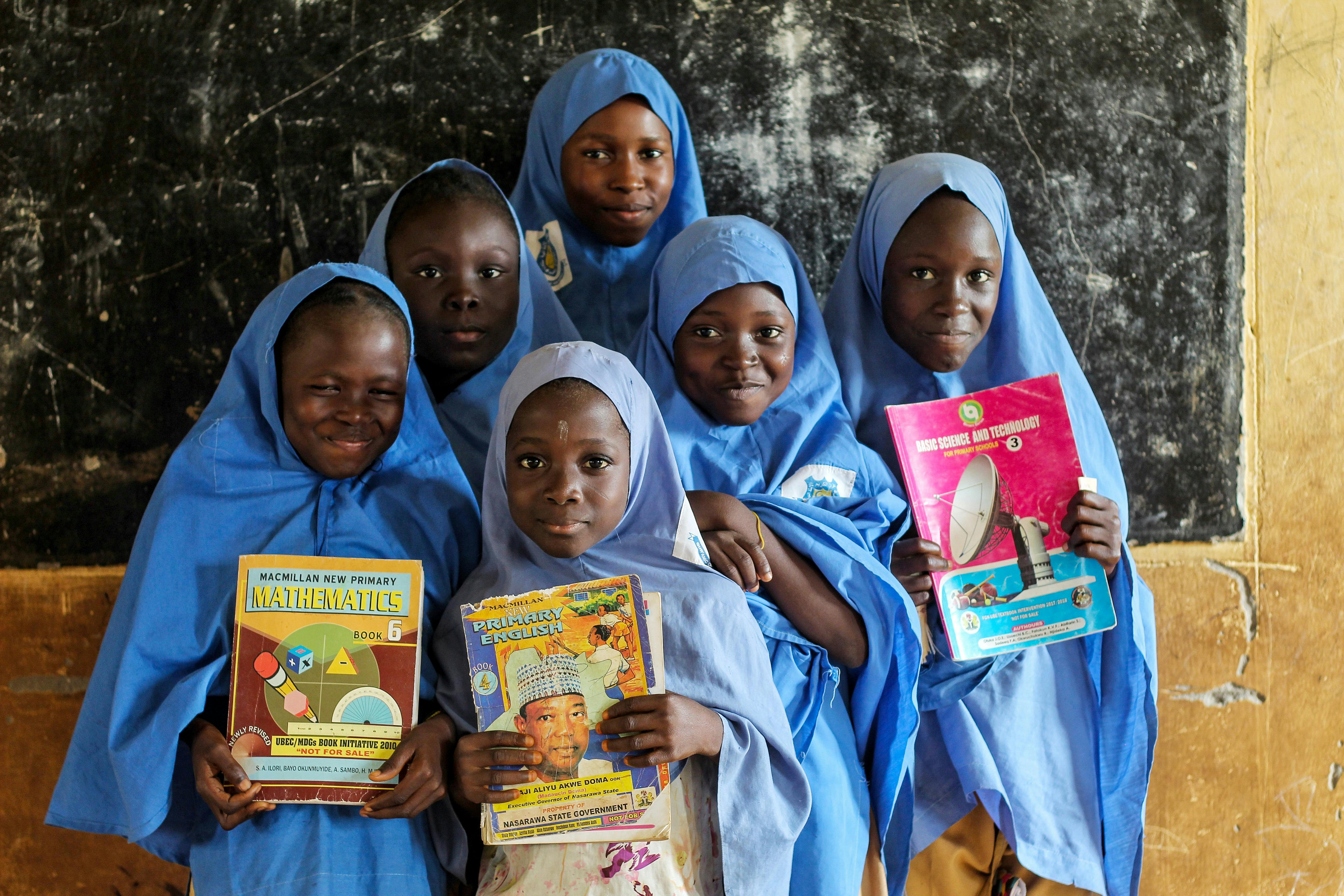Little Girls Holding their School Textbooks · Free Stock Photo