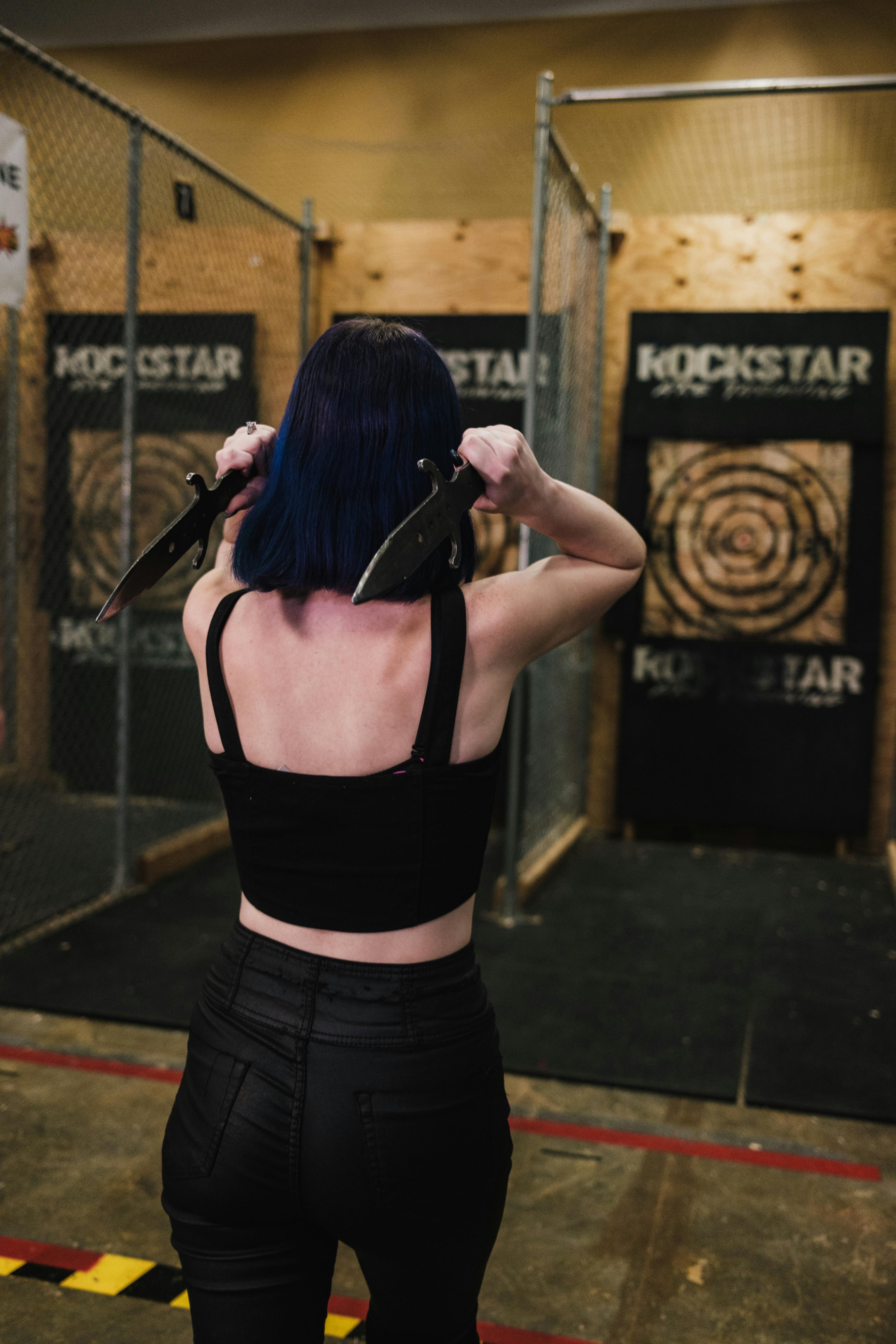 A Woman in a Crop Top Throwing Daggers · Free Stock Photo