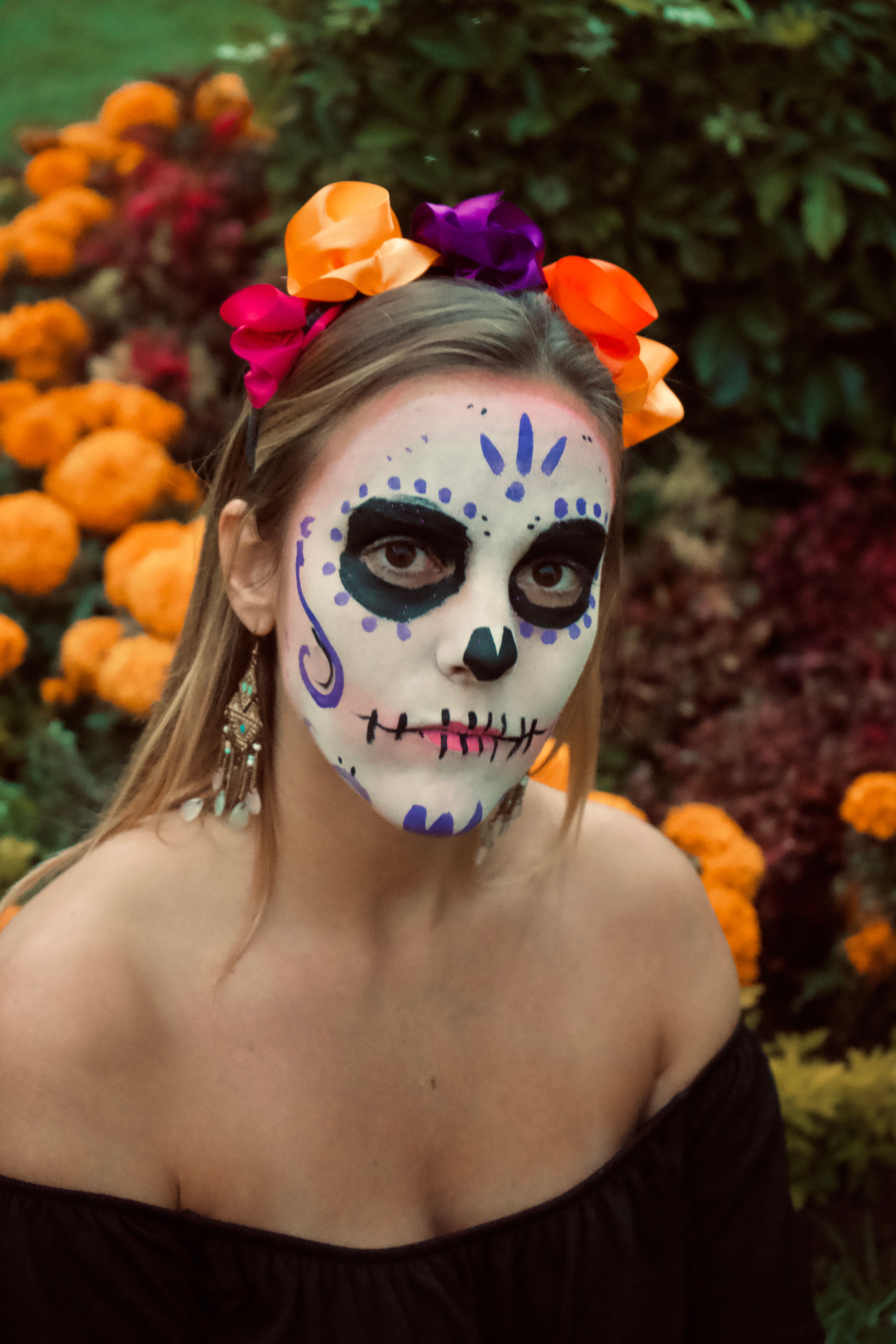 Portrait of a Woman with Death Painted Mask, and Flowers in Background ...