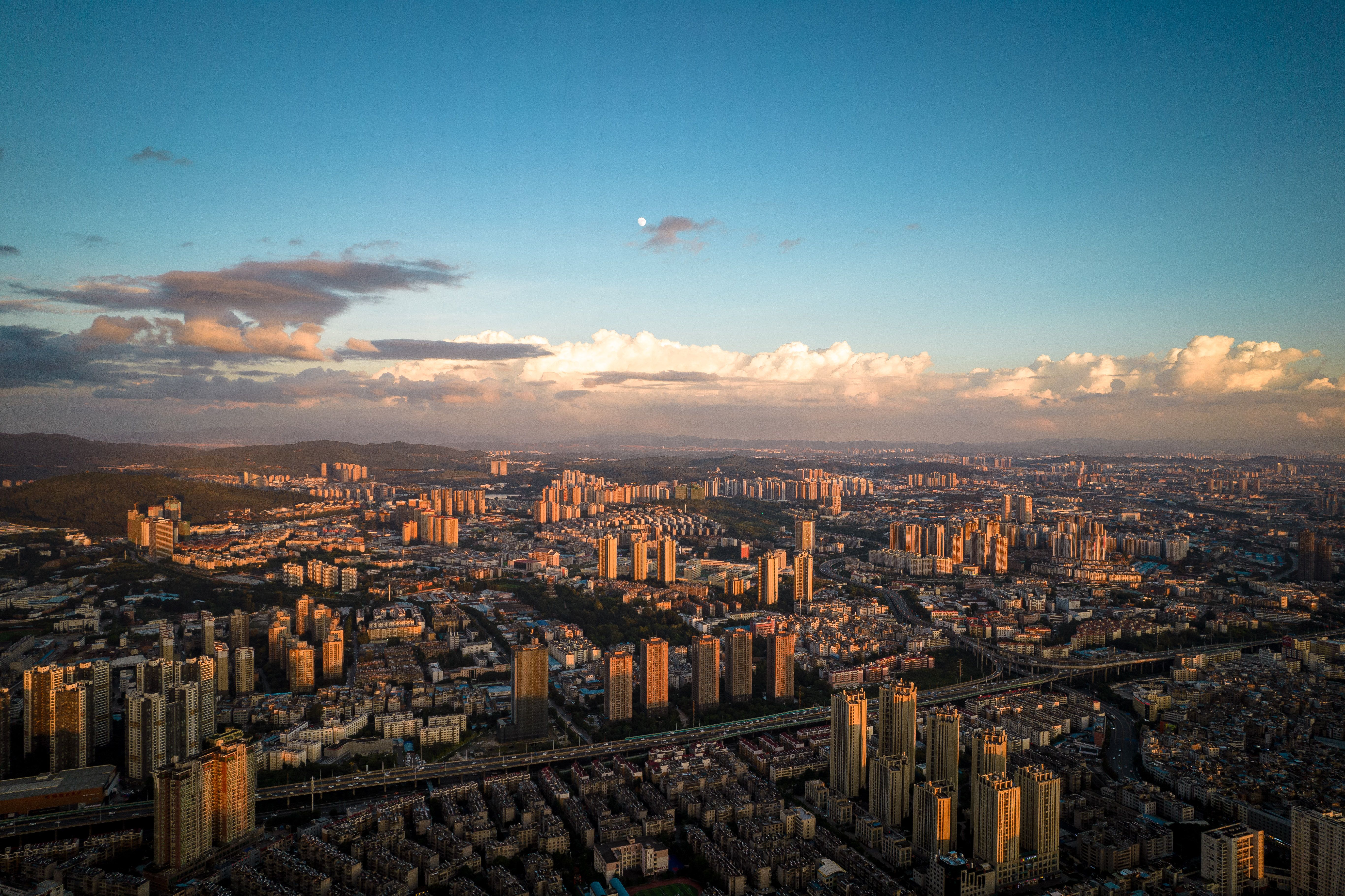 Drone Shot of a Modern City with Skyscrapers at Sunset · Free Stock Photo