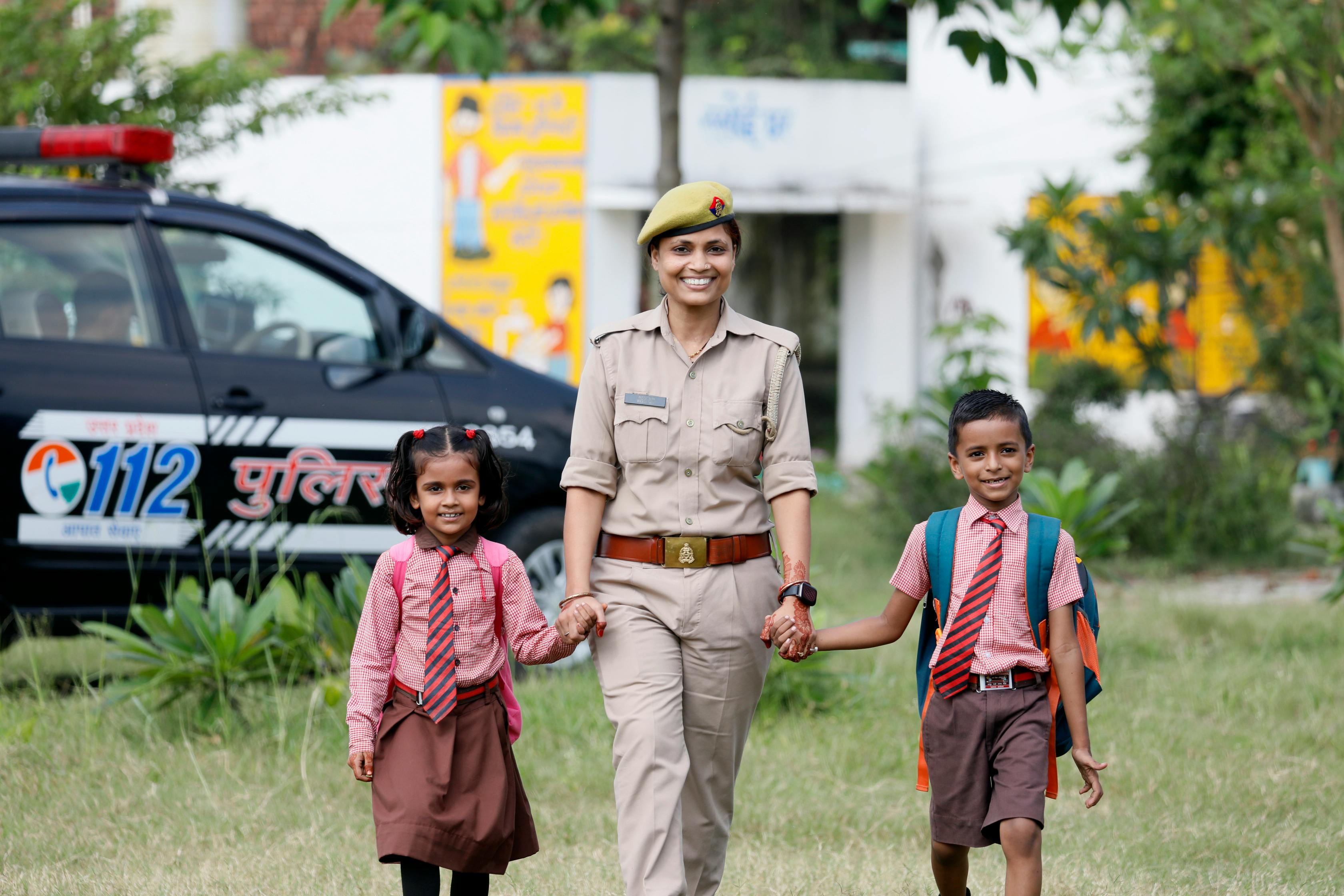 Smiling Police Officer Walking with Children · Free Stock Photo