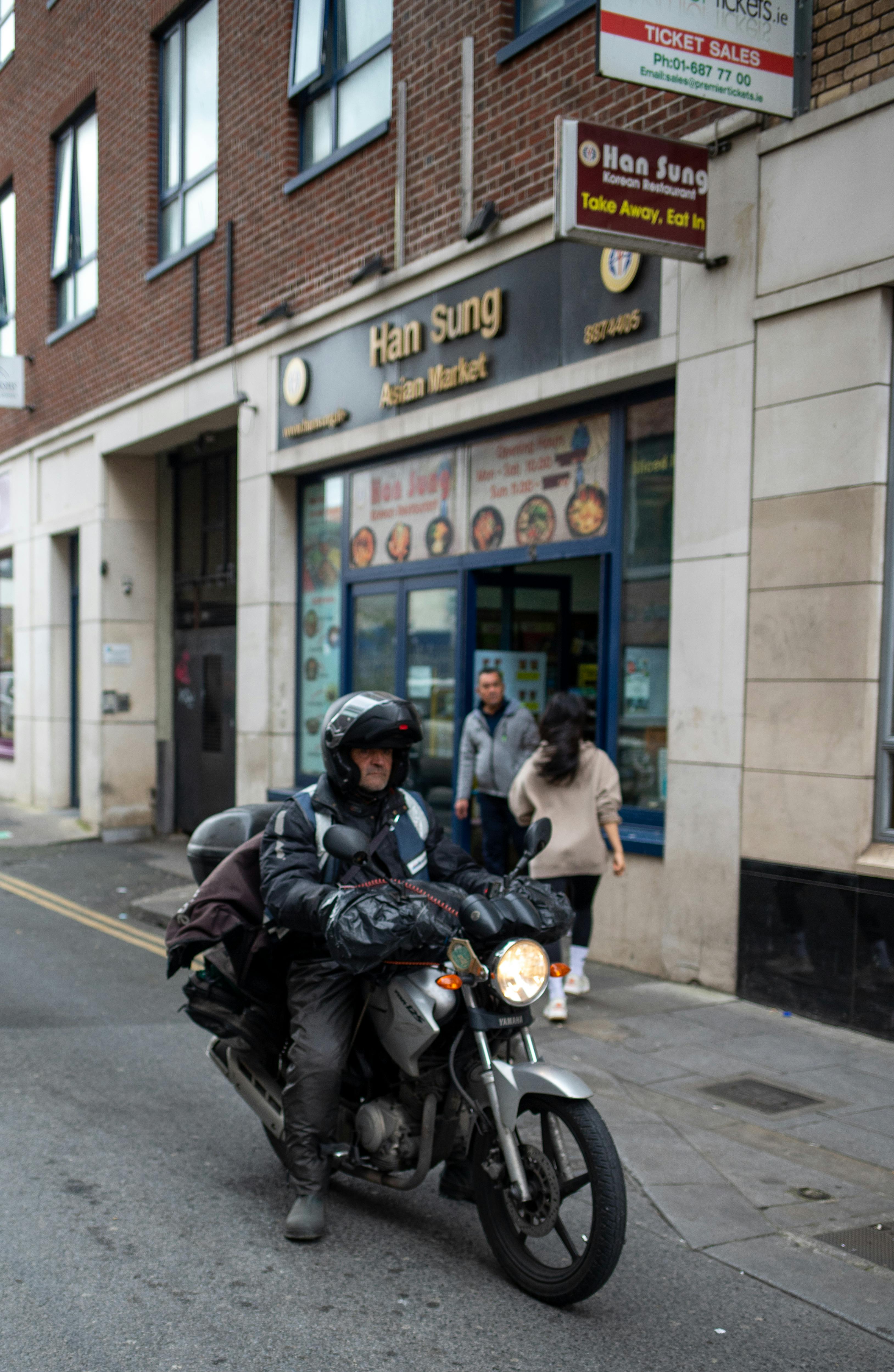 Man in Suit Riding Motorcycle on City Street · Free Stock Photo