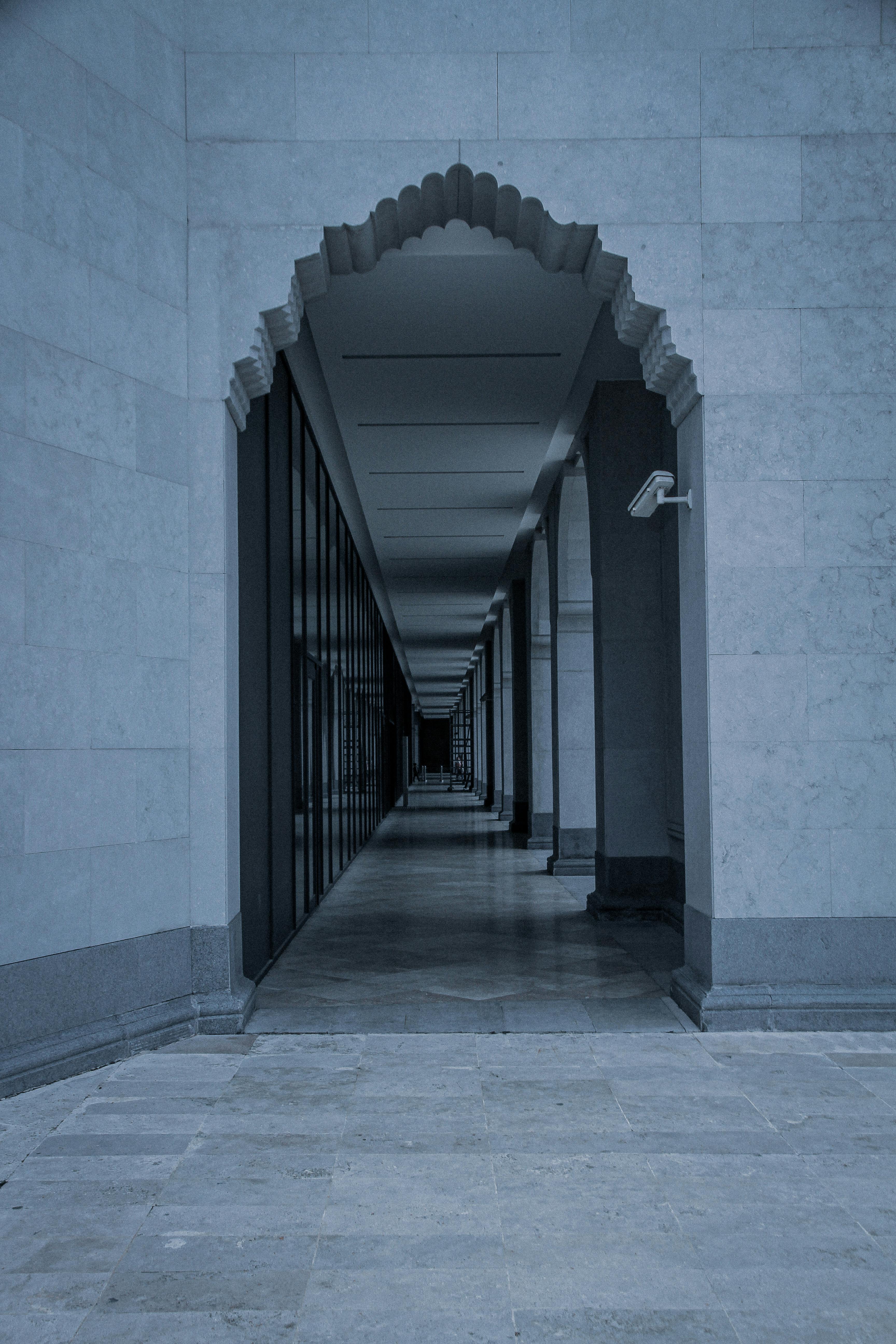 Symmetrical View of a Corridor with an Arched Entrance · Free Stock Photo