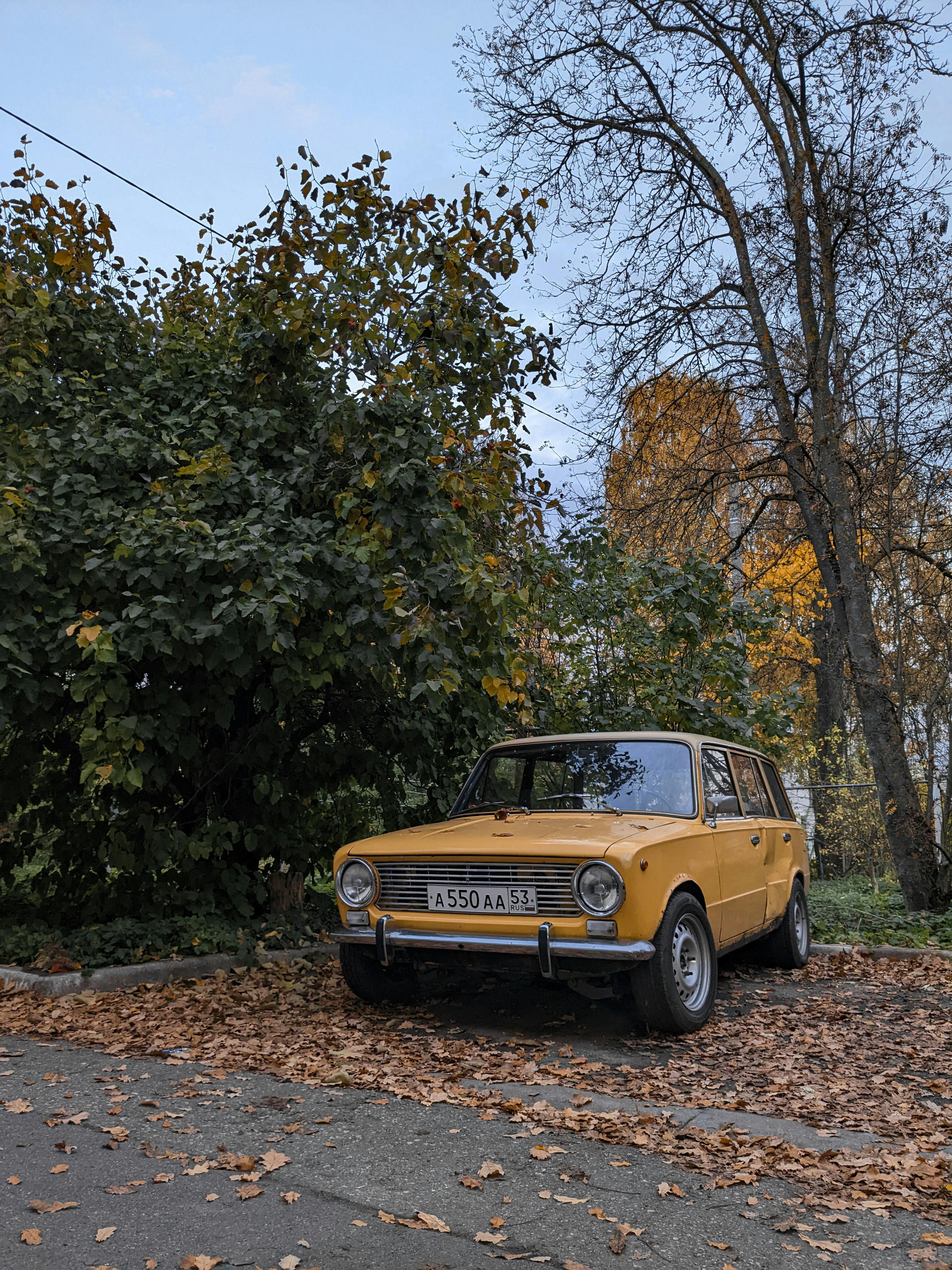 Photo of Yellow Car parked on parking Lot · Free Stock Photo